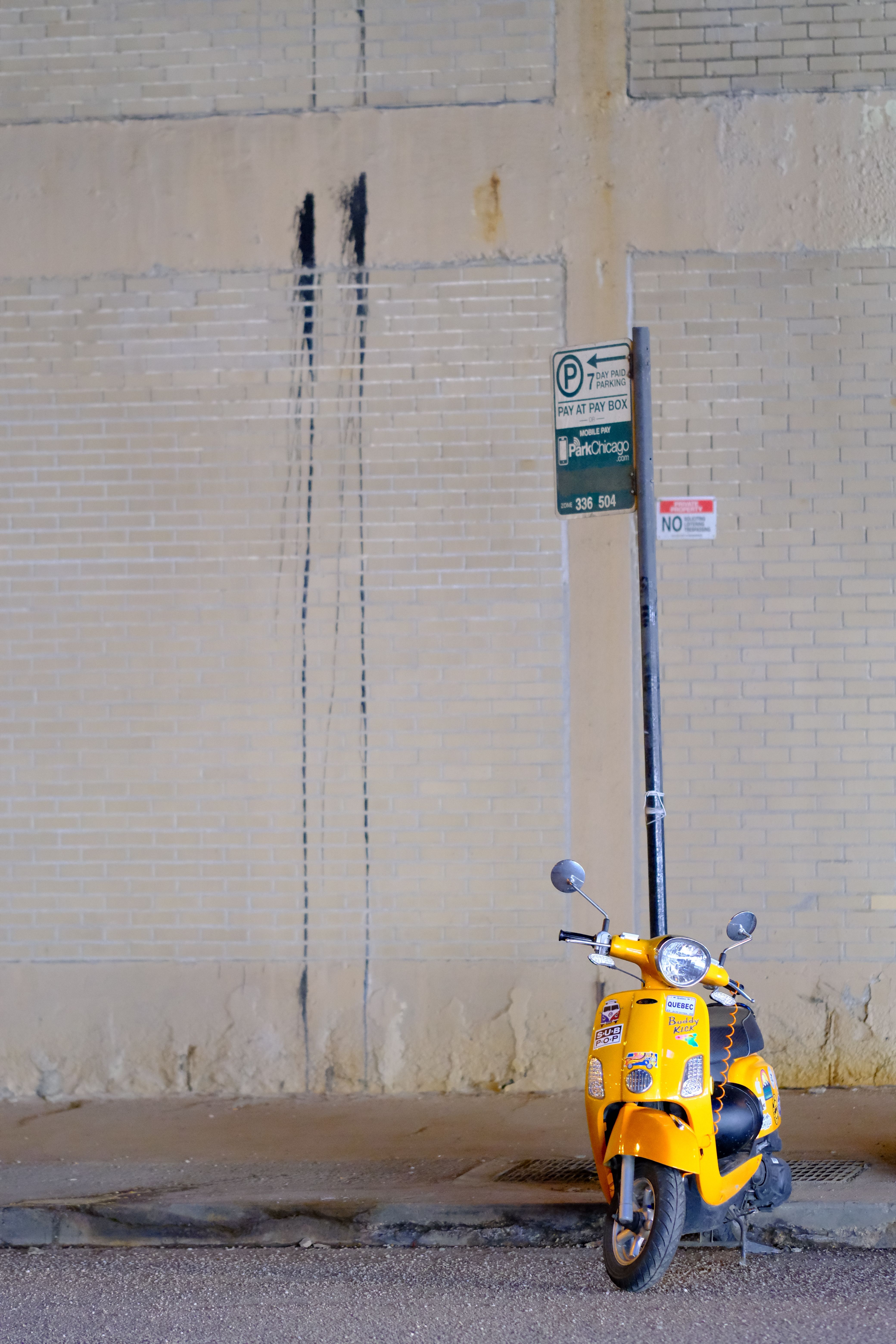 Yellow Motor Scooter Locked by Pole · Free Stock Photo
