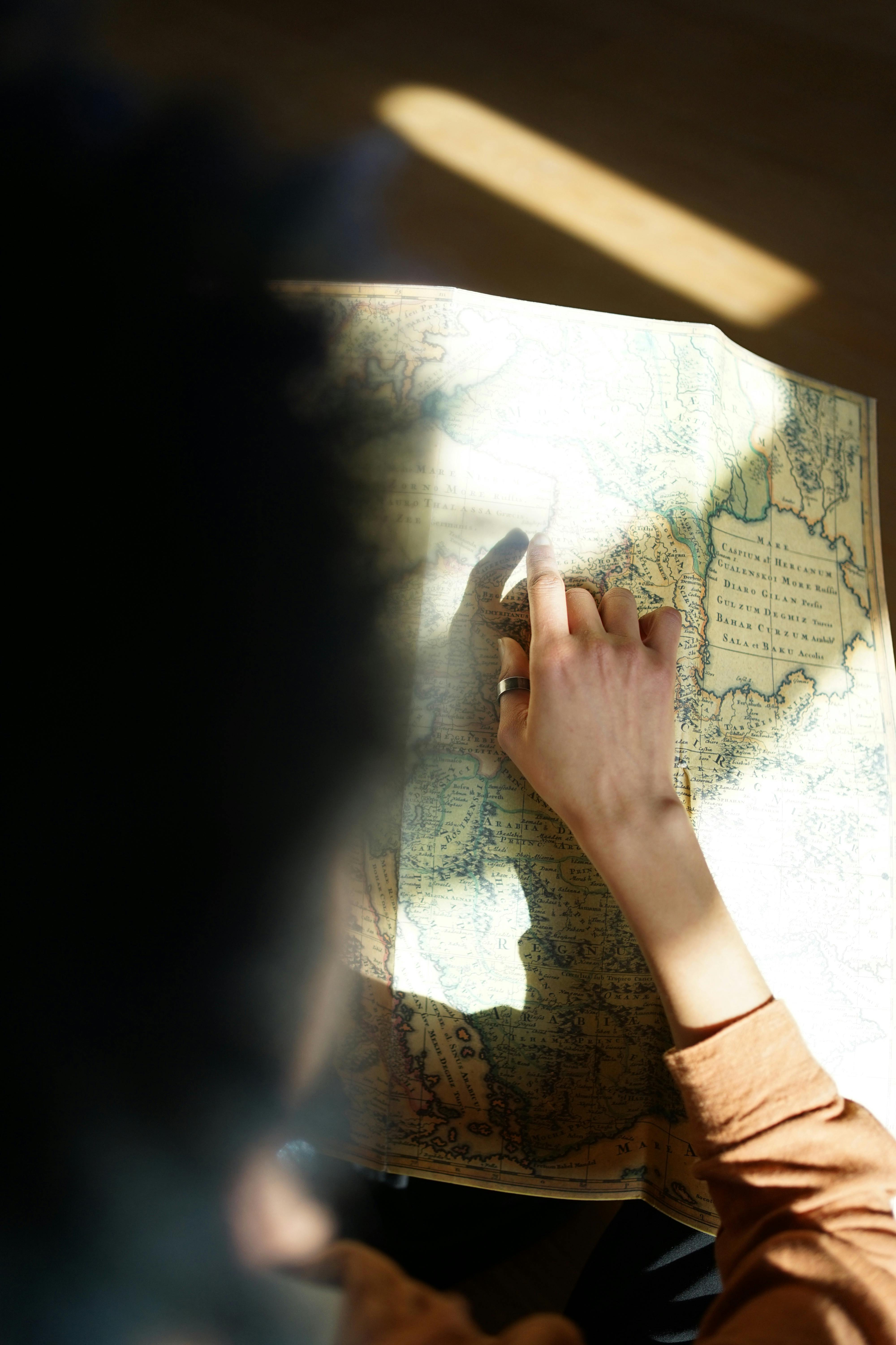 Woman Holding Hand on Map · Free Stock Photo
