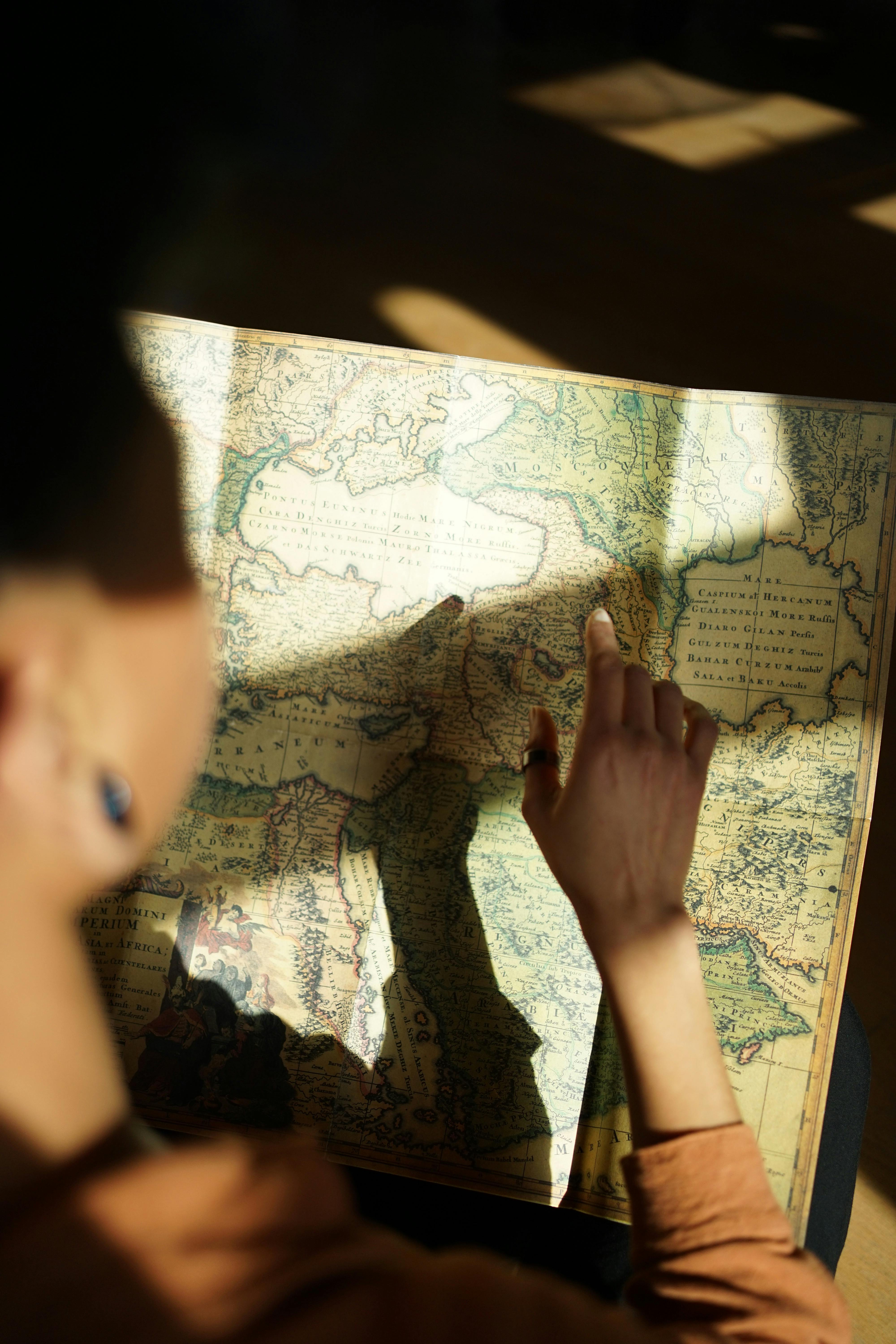 Woman Hand on Map · Free Stock Photo