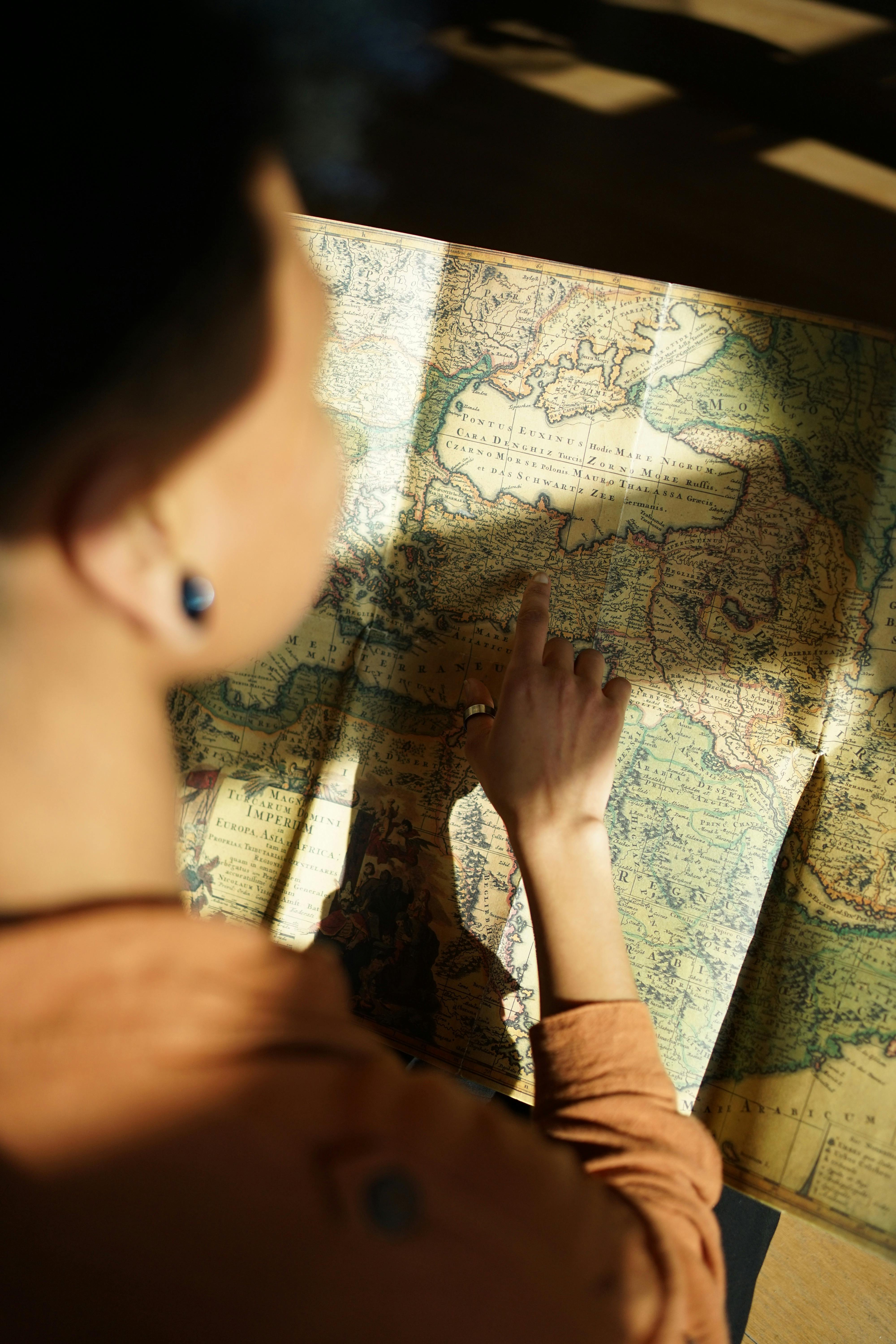 Woman Holding Hand on Map · Free Stock Photo