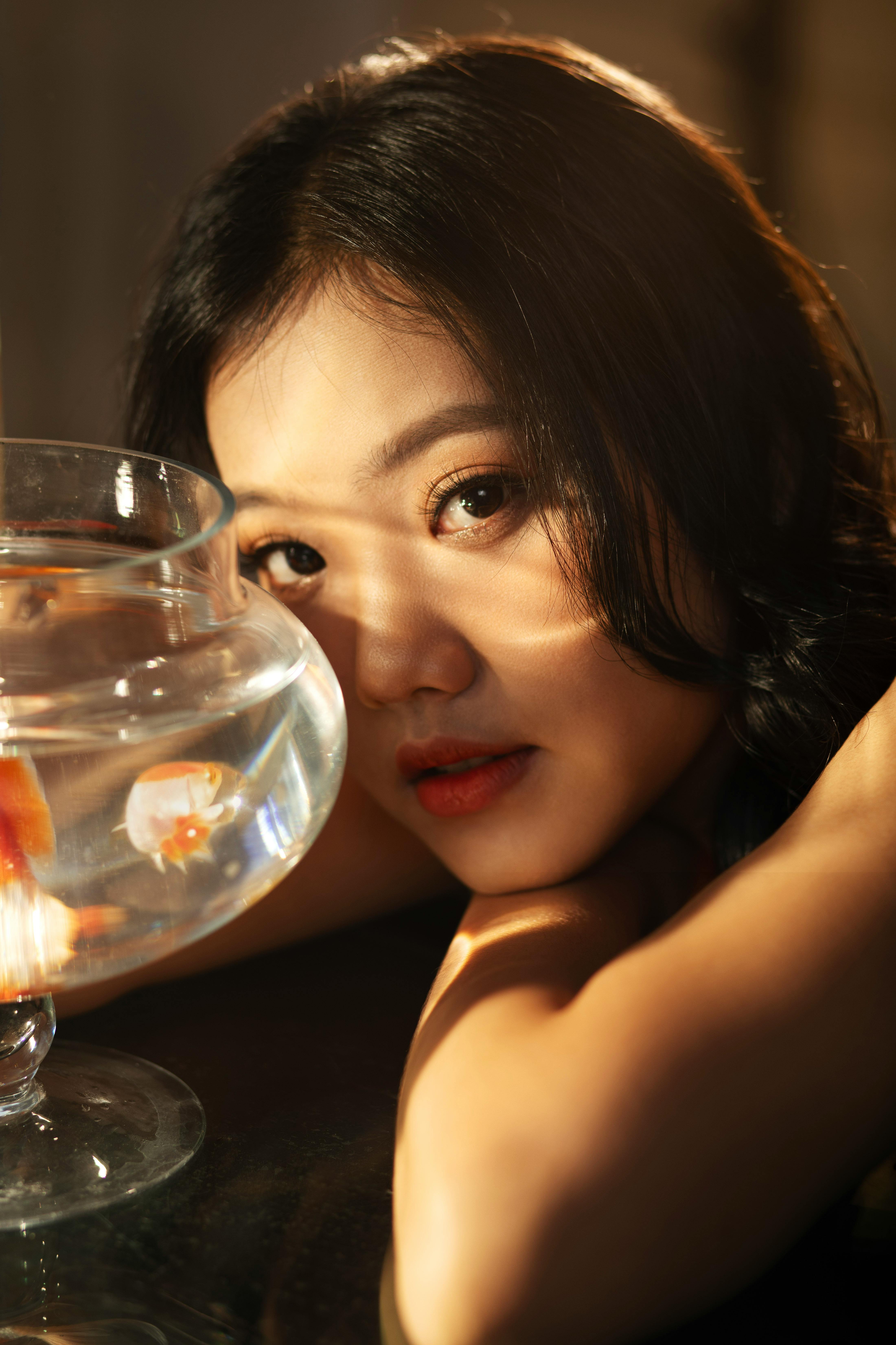 Portrait of Woman with Glass Bowl of Fish · Free Stock Photo