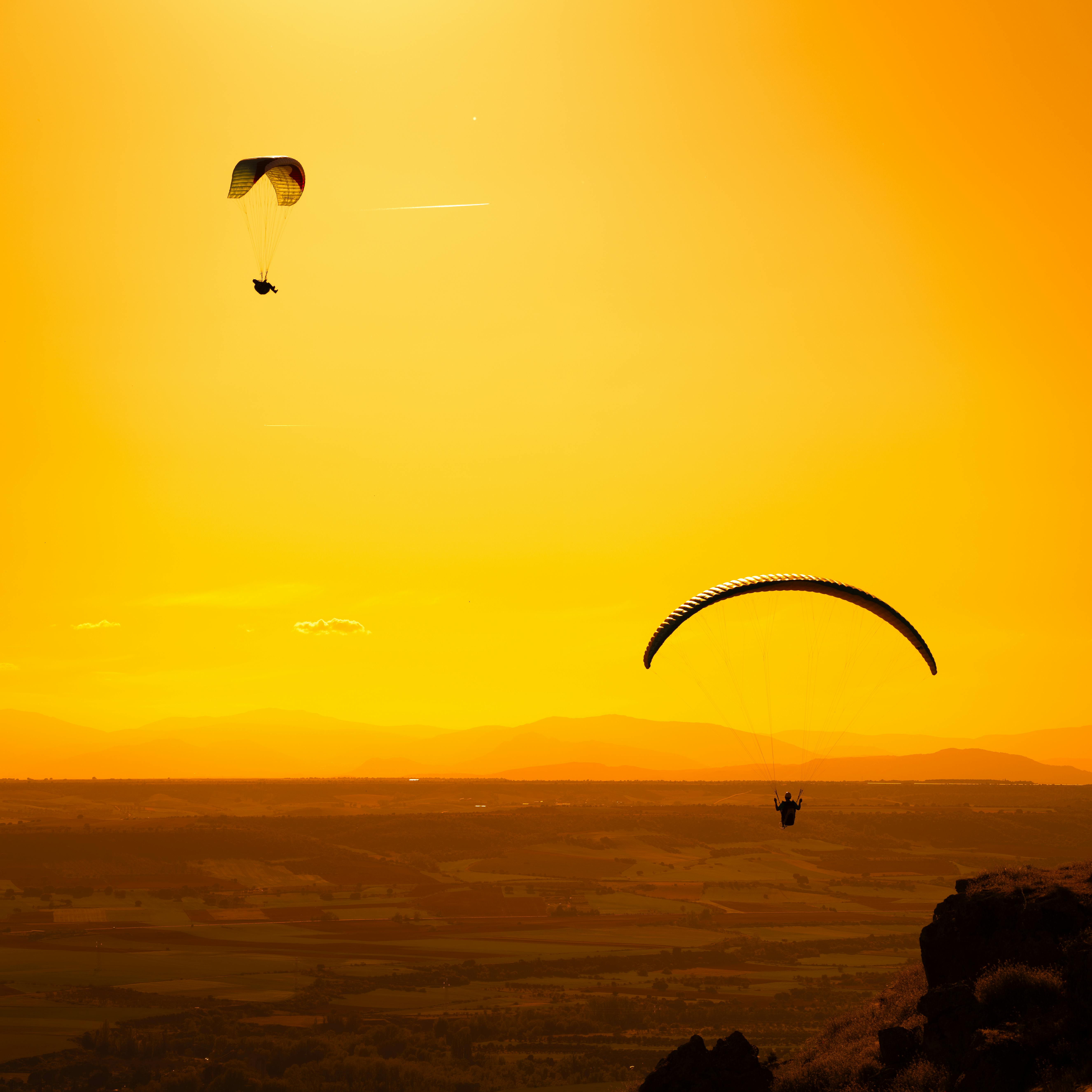 People Parachuting under Golden Sky at Sunset · Free Stock Photo
