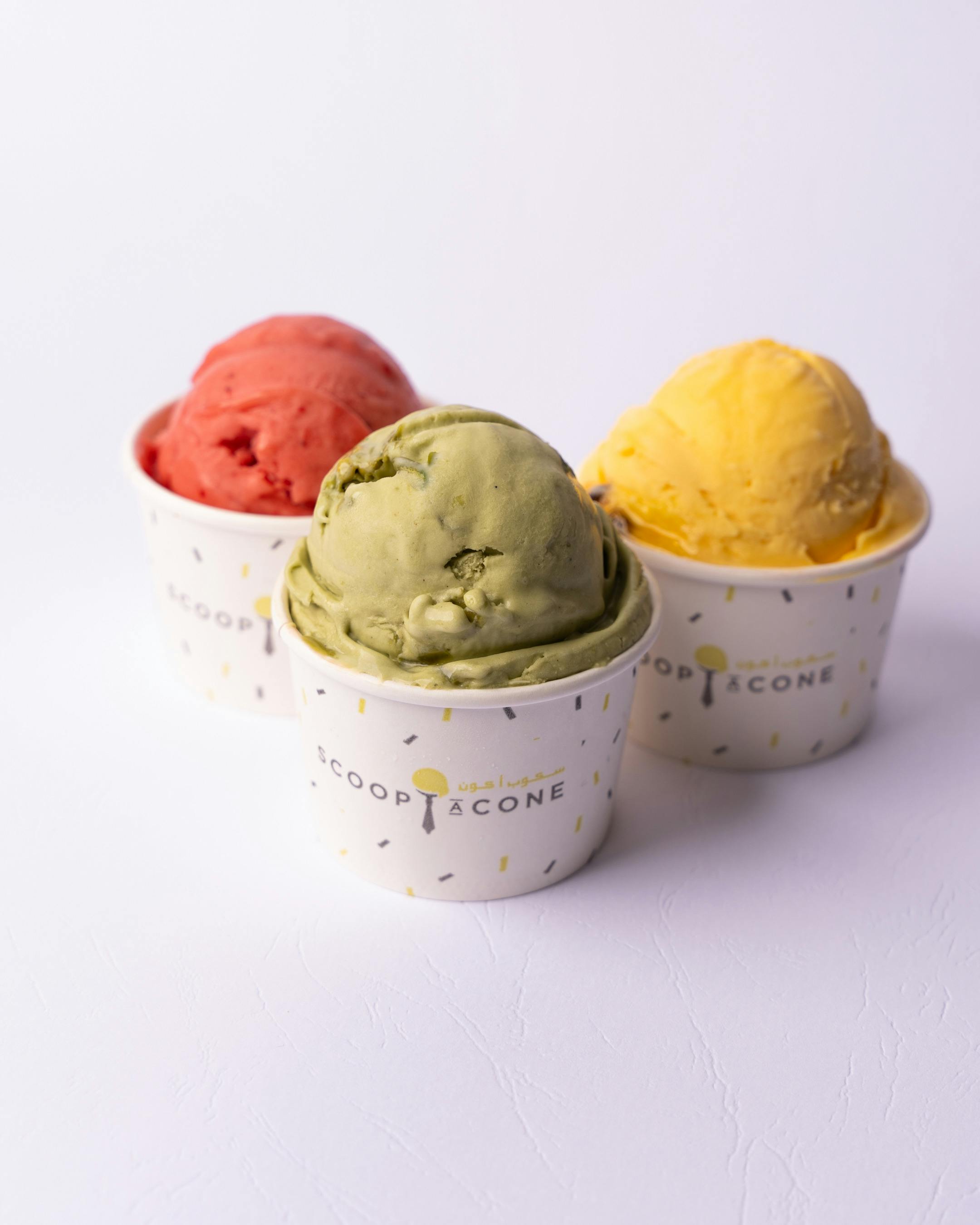 Three different colored ice cream in cups · Free Stock Photo