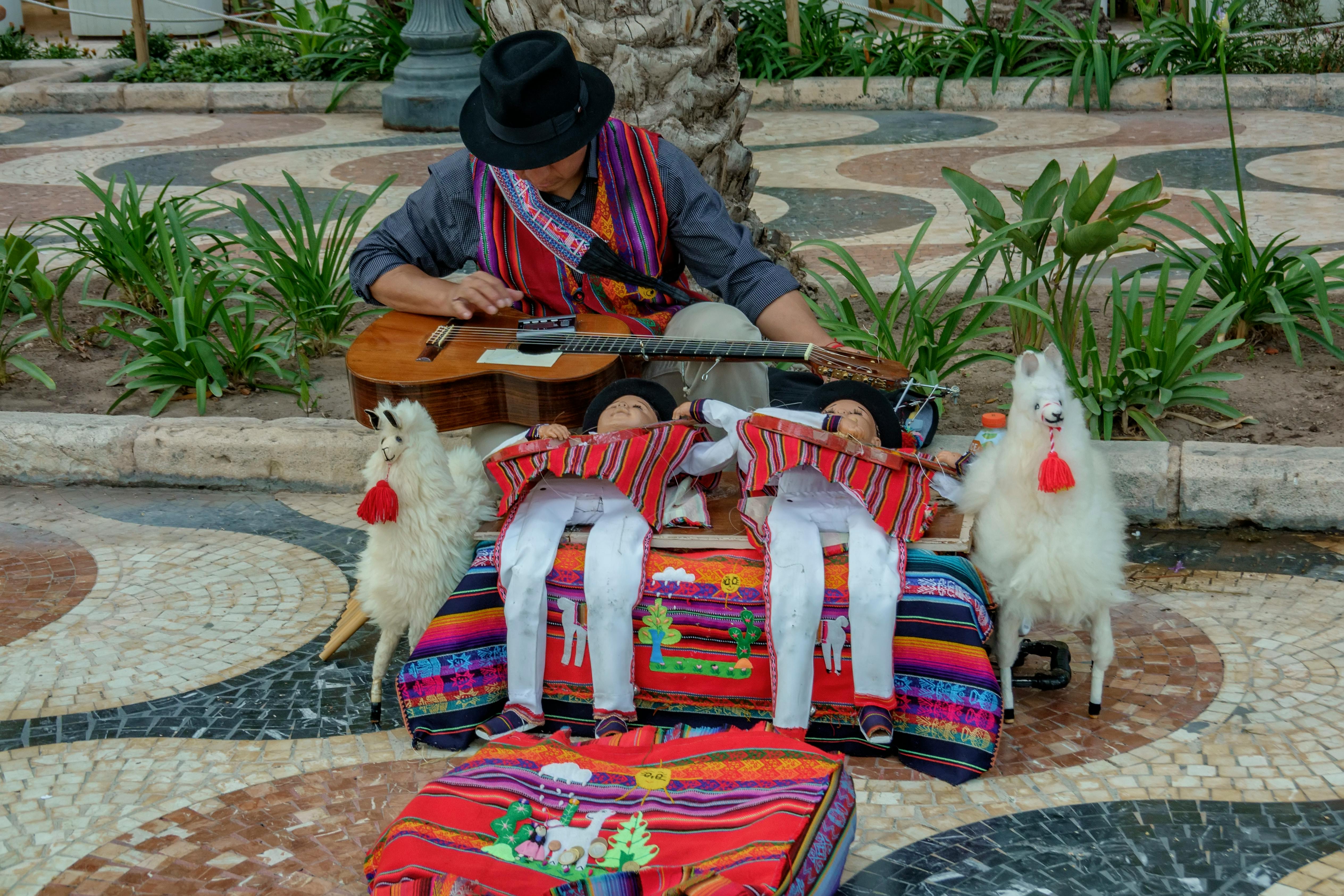 Man Playing Guitar among Puppets · Free Stock Photo