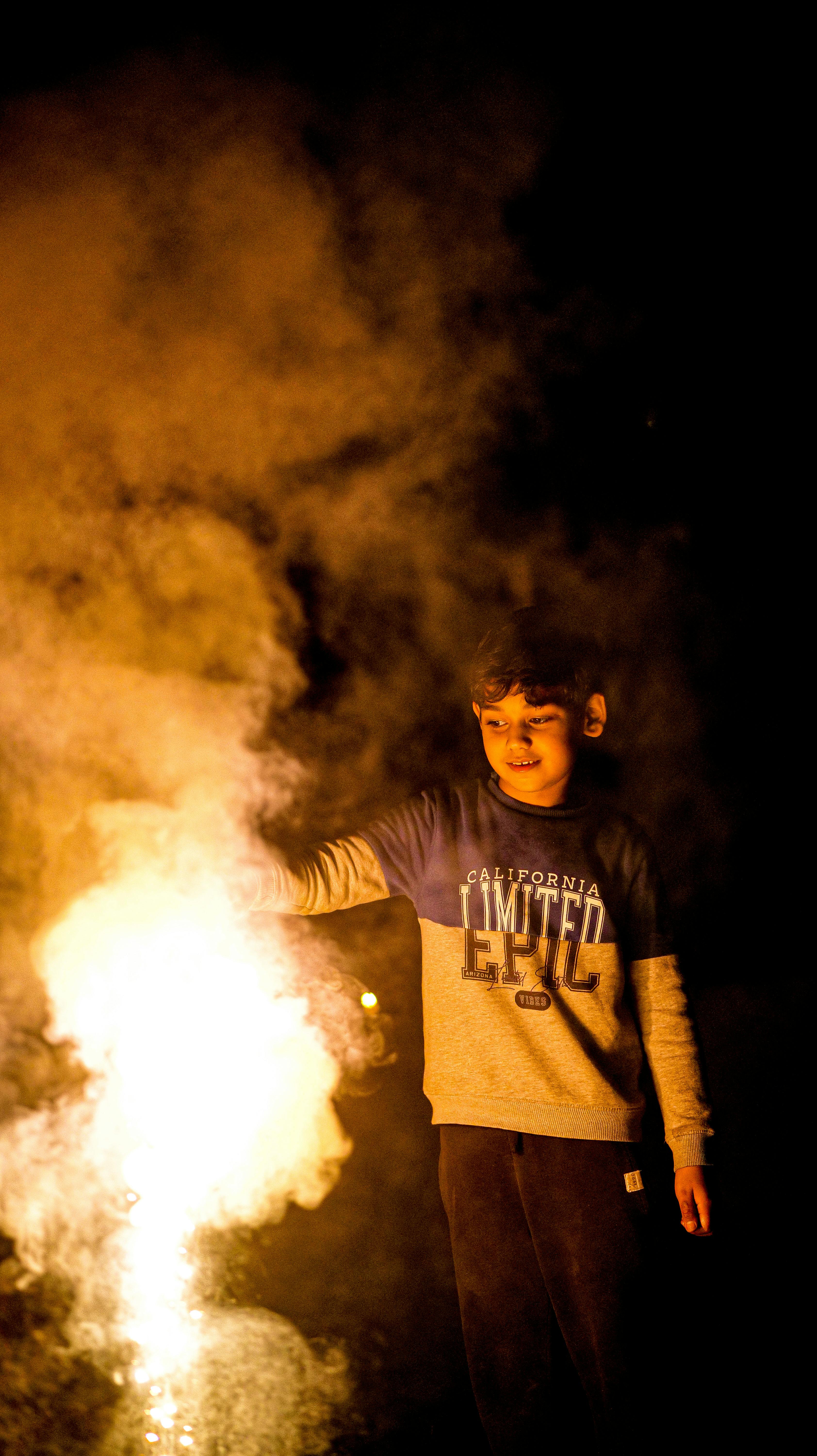 Boy Playing with Smoke Flare at Night · Free Stock Photo