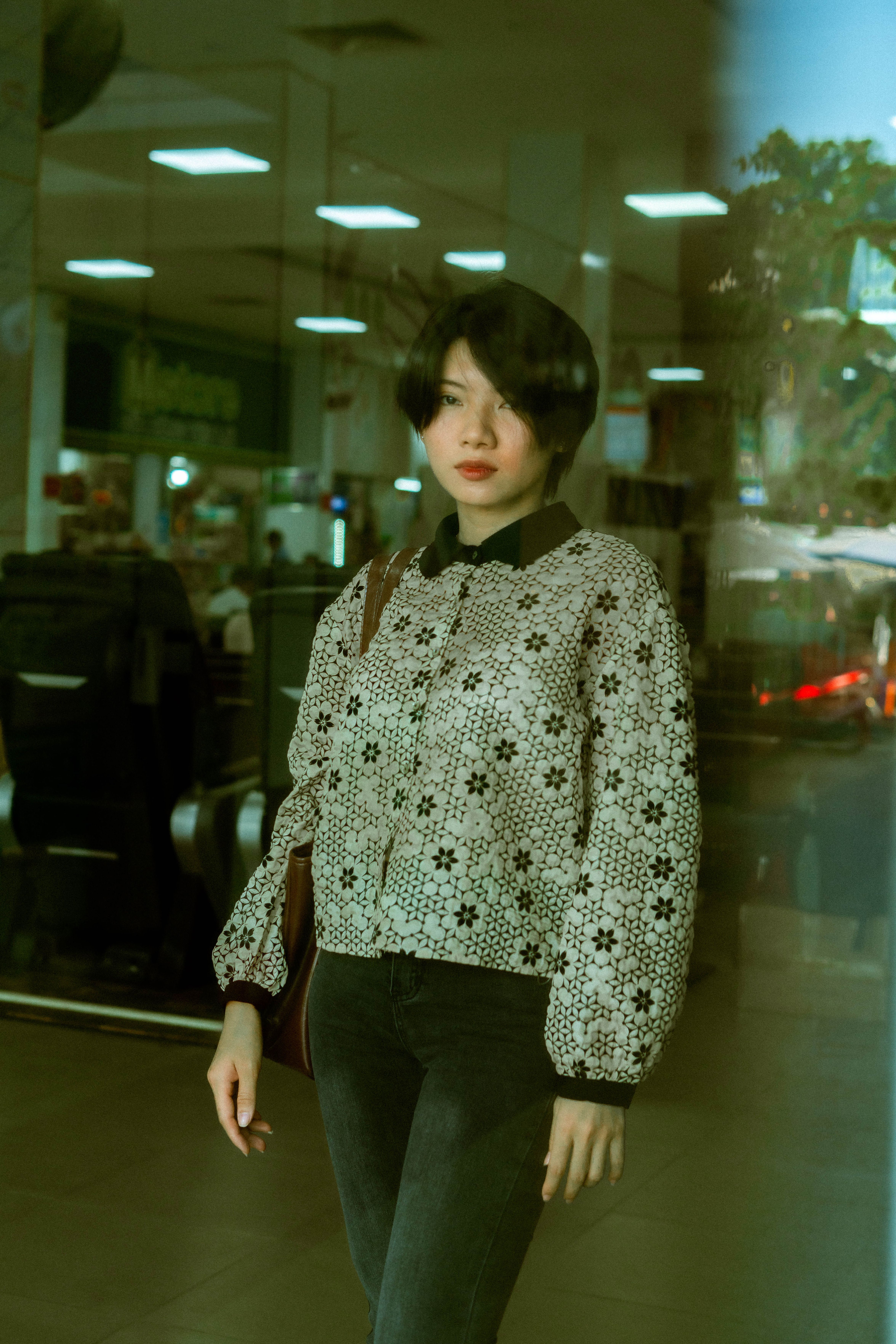 Young Woman in a Patterned Jacket Posing in a City · Free Stock Photo