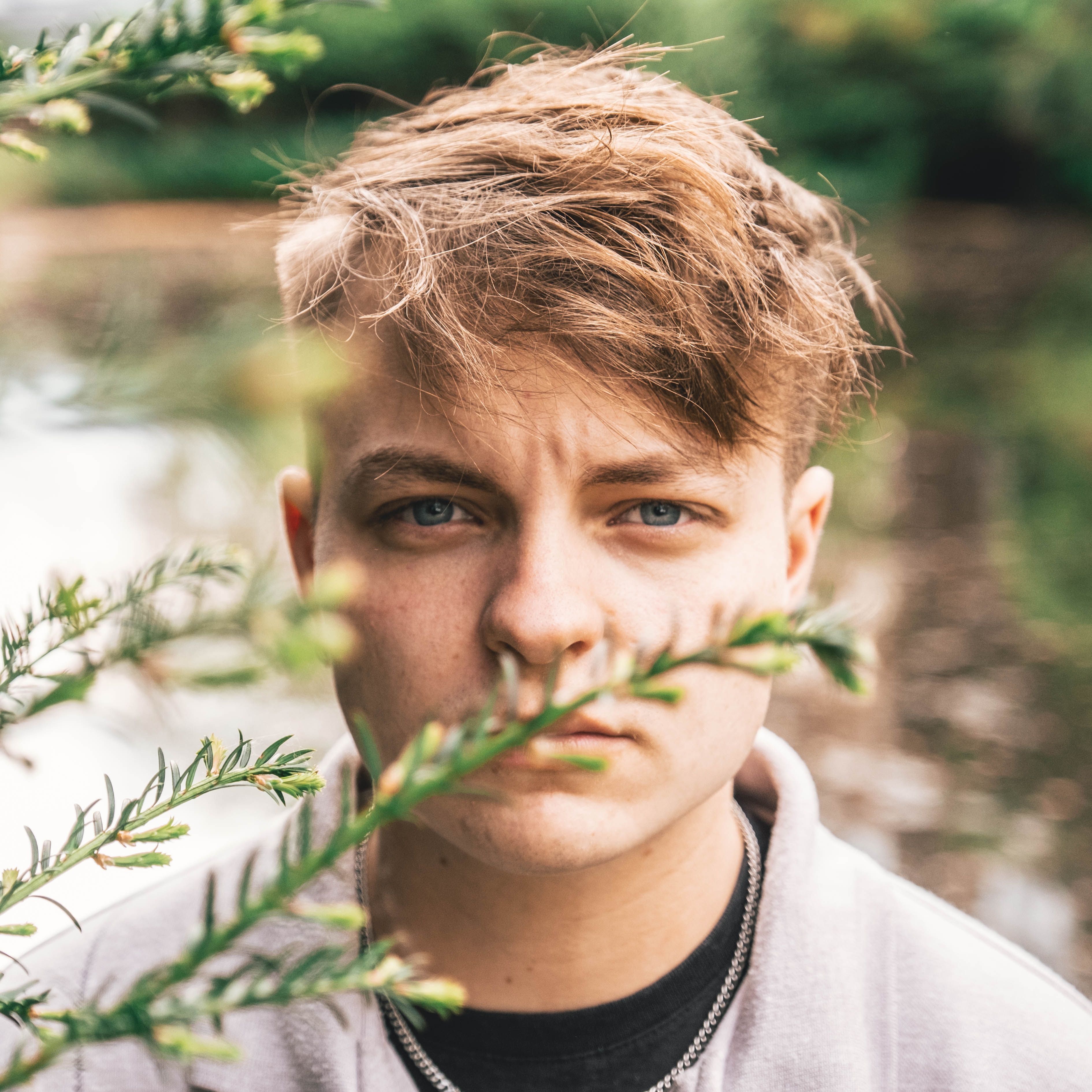 Man Standing Behind Leaves · Free Stock Photo