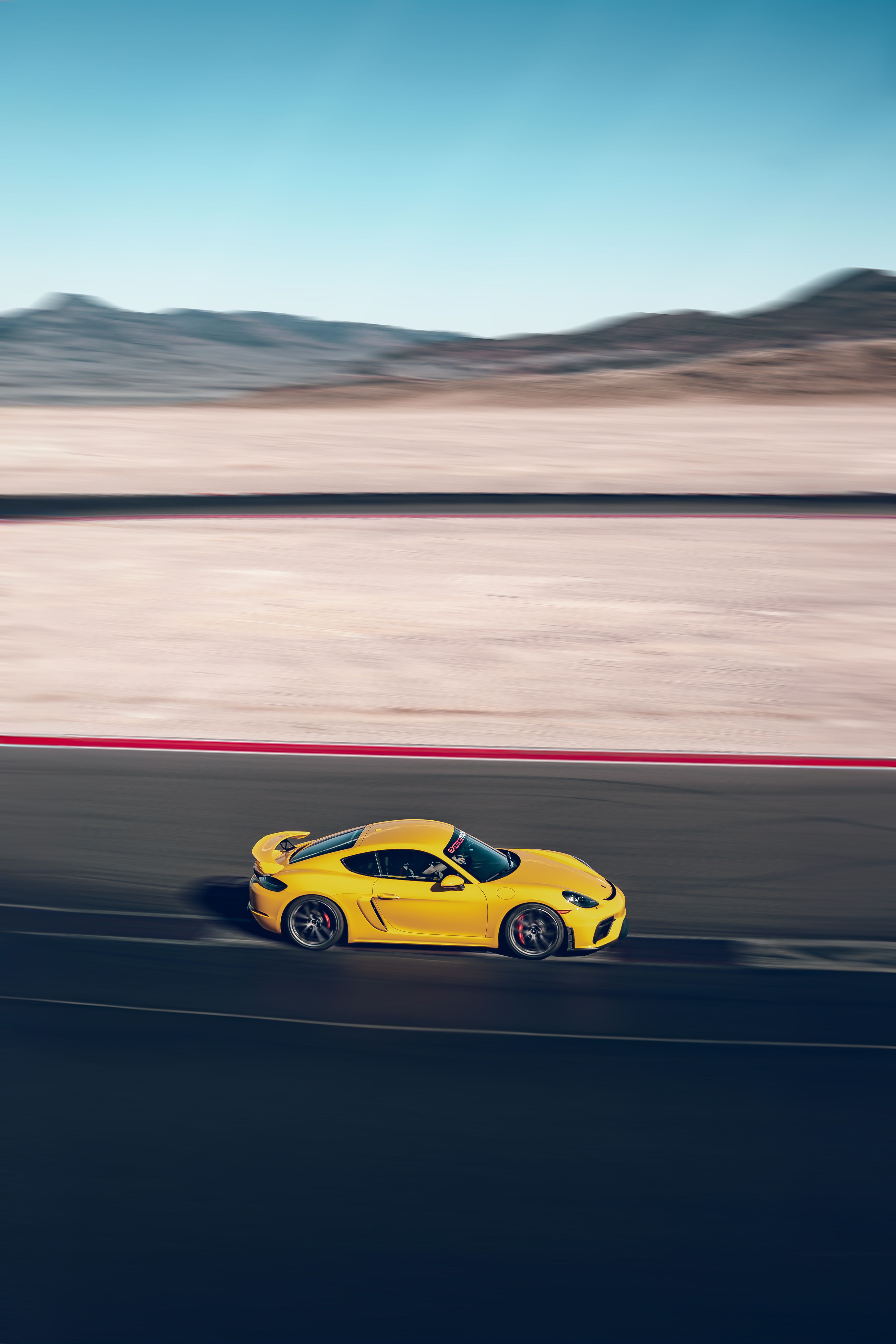 Aerial View of a Yellow Sports Car Driving on the Track · Free Stock Photo