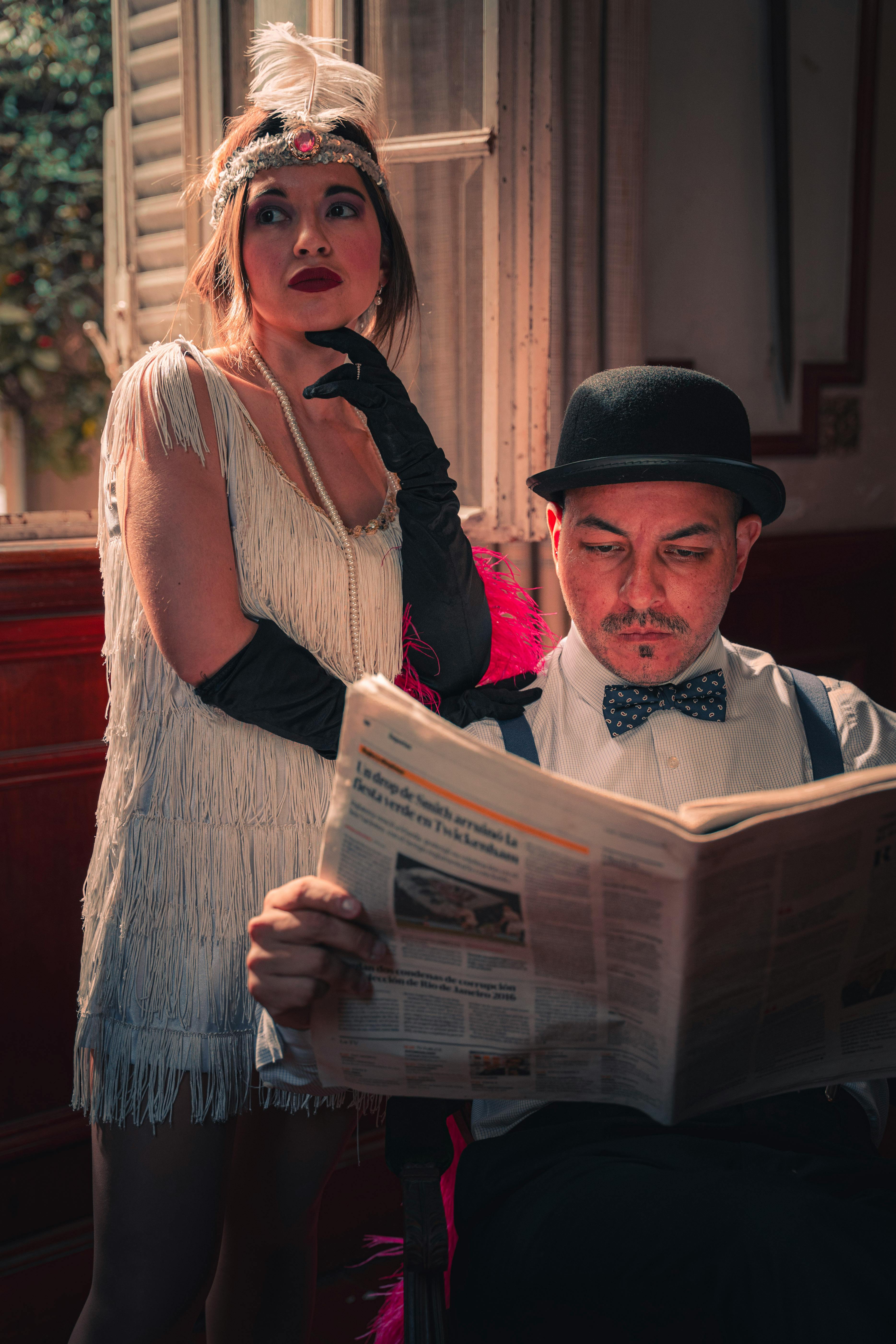Woman in a White Flapper Dress Standing Next to a Man in a Bowler Hat ...