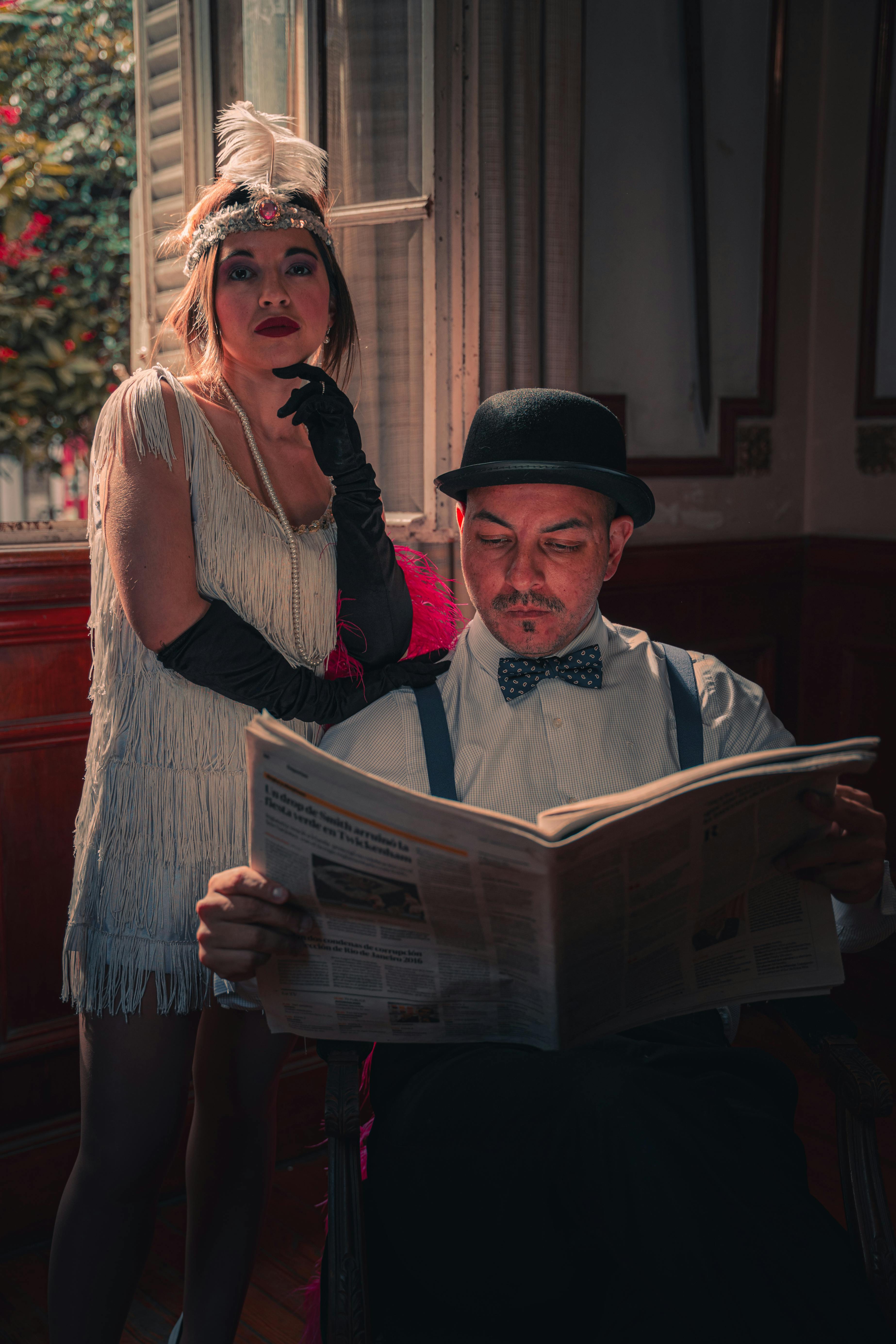 Woman in a 1920s Style Flapper Dress And Man in Bowler Hat Reading ...