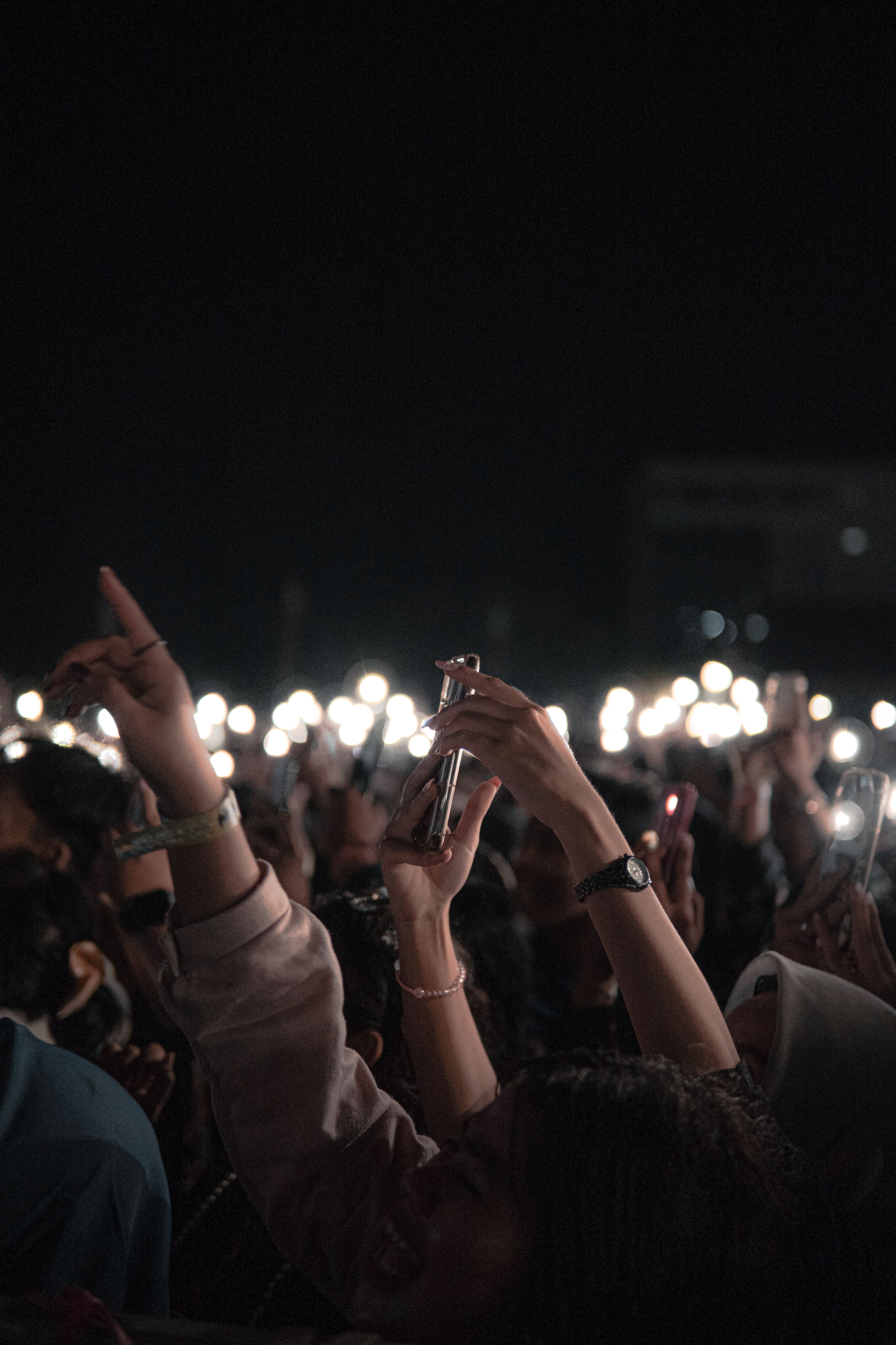 A crowd of people holding up their cell phones · Free Stock Photo