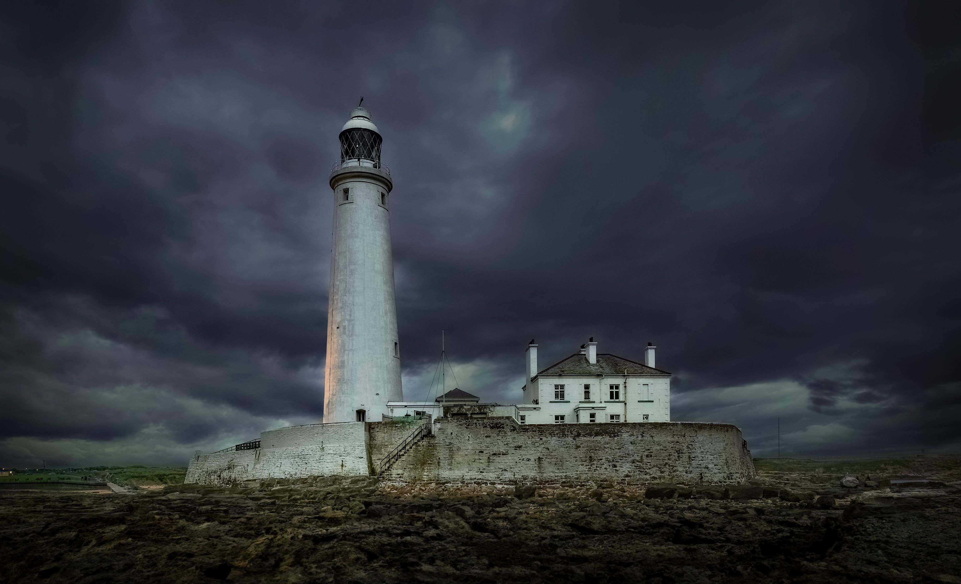 Dark Storm Clouds Above a Lighthouse at Dusk · Free Stock Photo