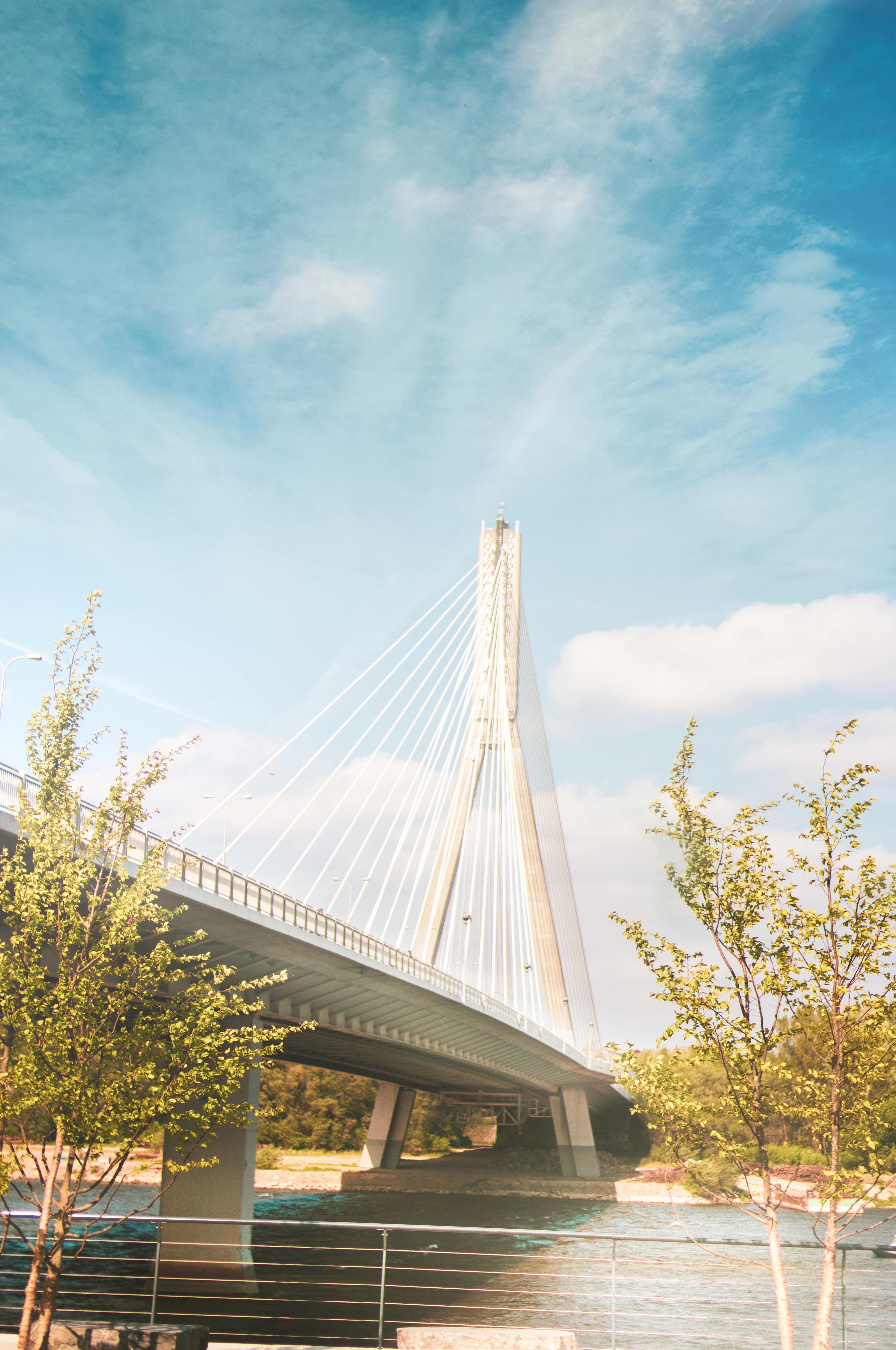 White Bridge Above Body of Water Creating a Reflection Under White ...
