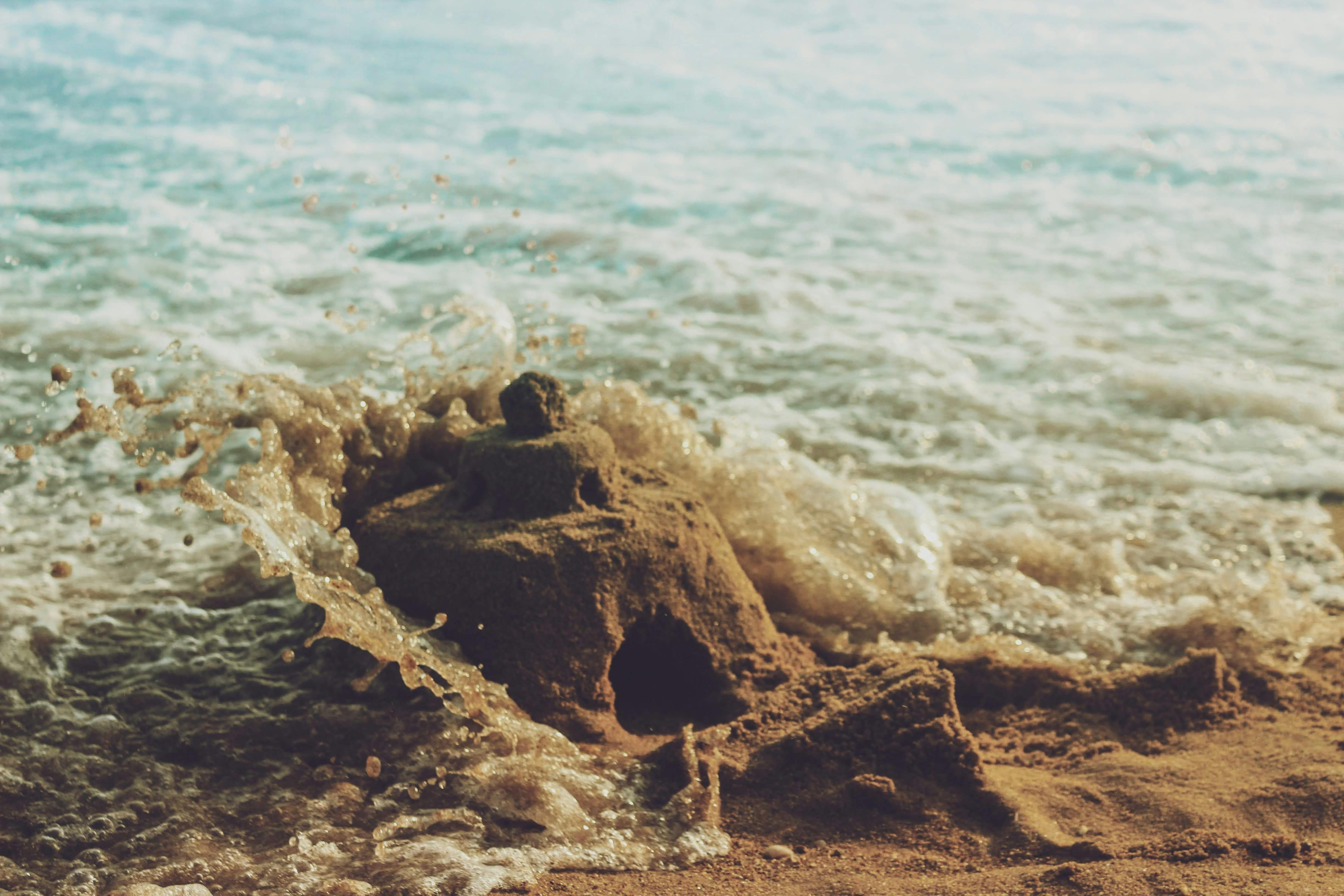 Waves Destroying Sand Castle · Free Stock Photo