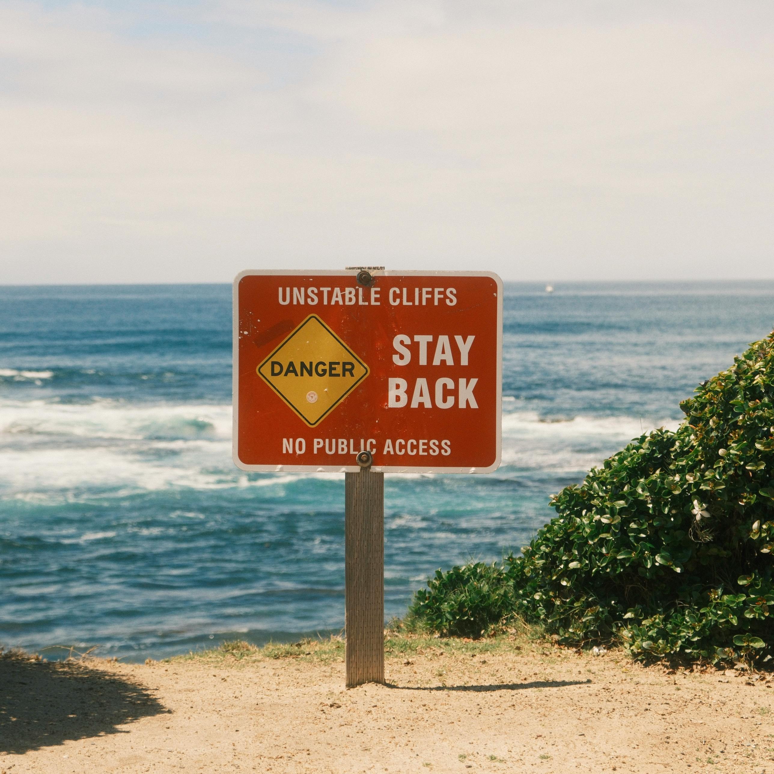 A Warning Sign on a Cliff · Free Stock Photo