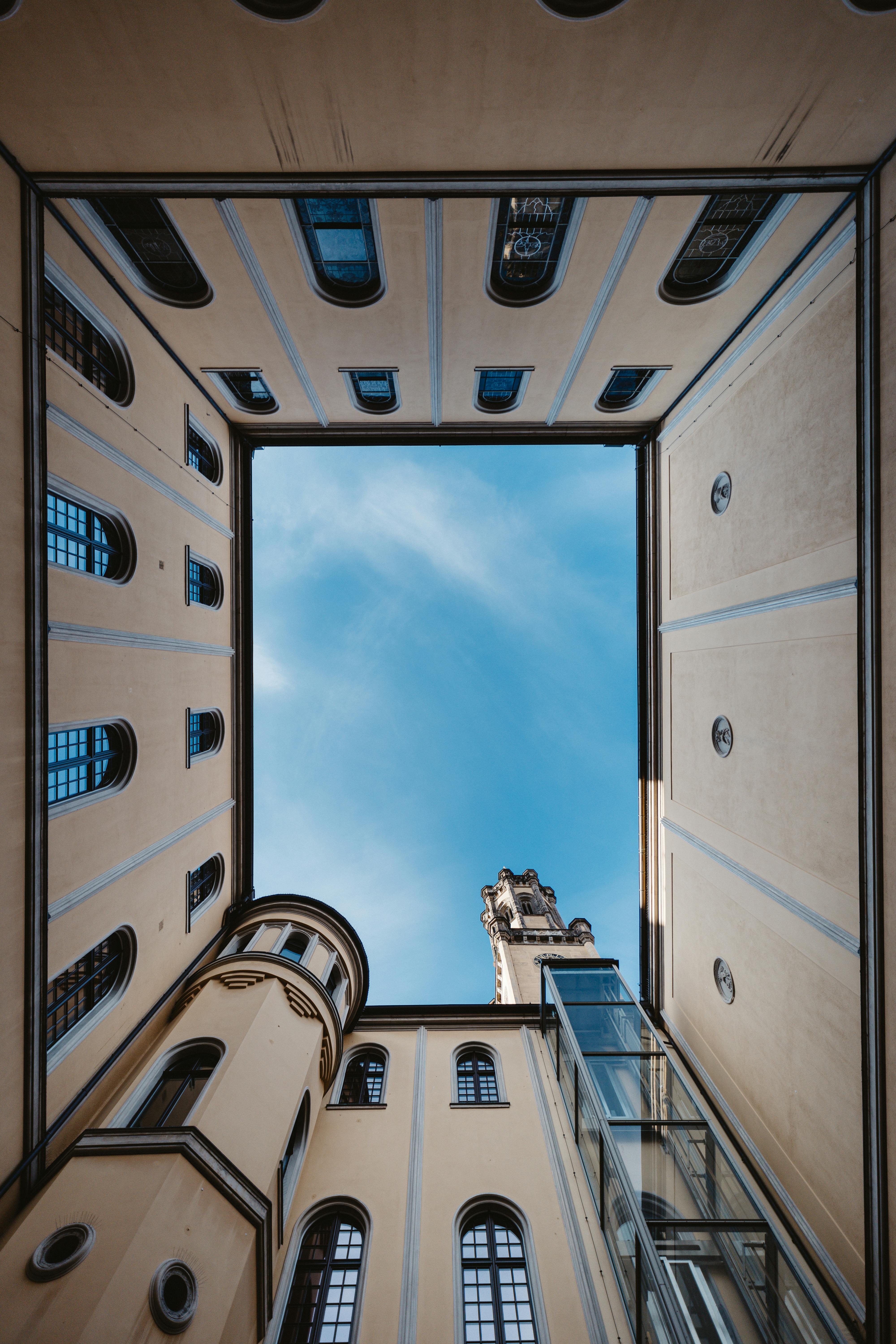 A view of a building from the ground looking up · Free Stock Photo