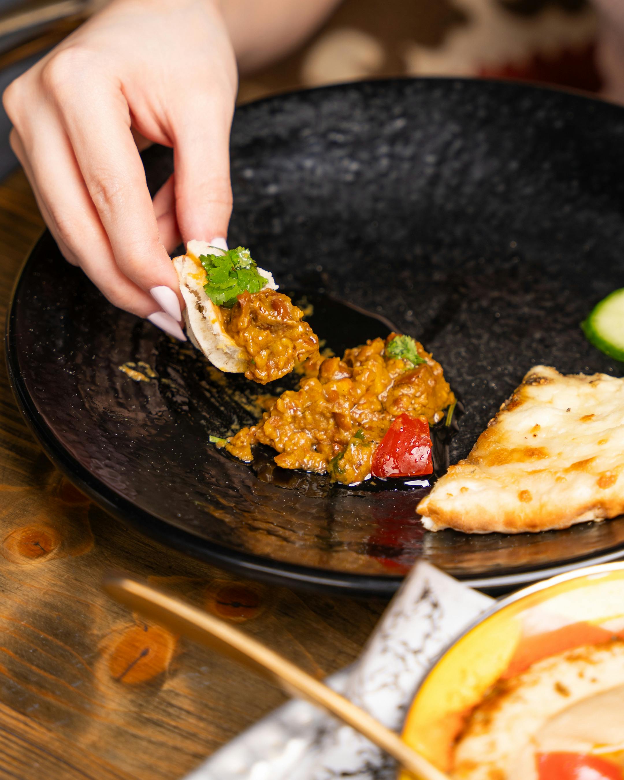 Hand of Woman over Food on Plate · Free Stock Photo