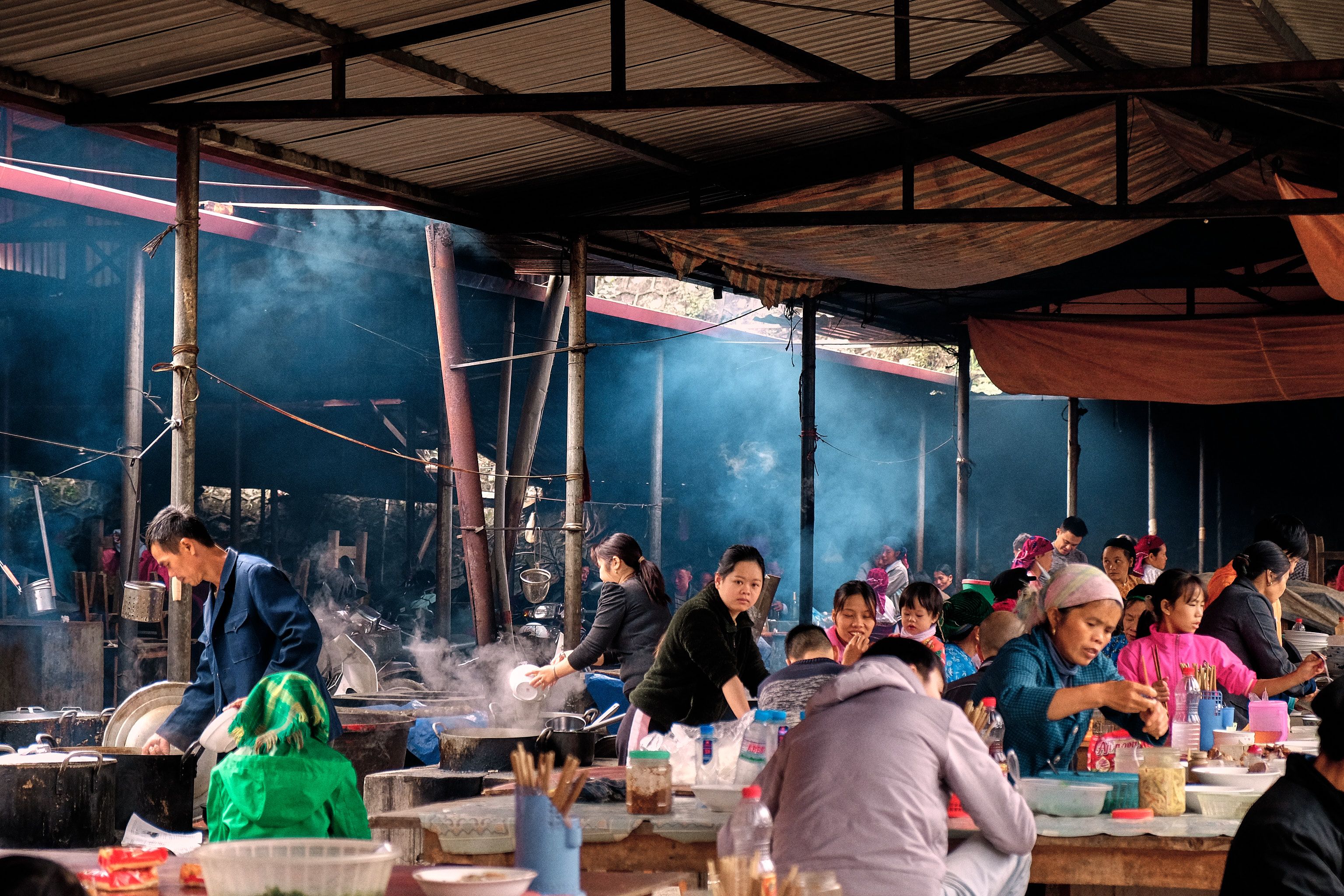 People eating at a food stall in a market · Free Stock Photo
