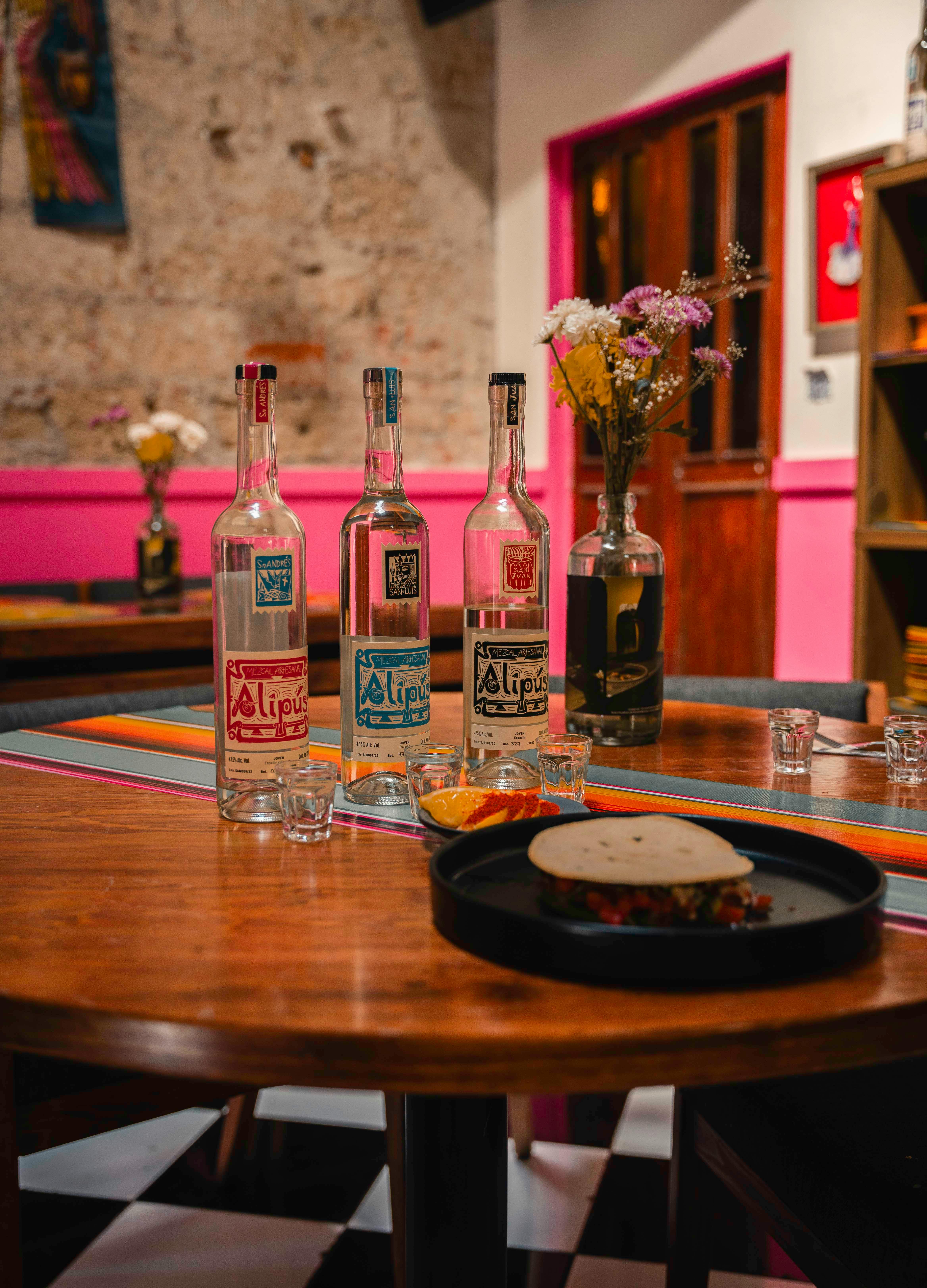 Sandwich and Bottles of Alcohol in a Restaurant · Free Stock Photo