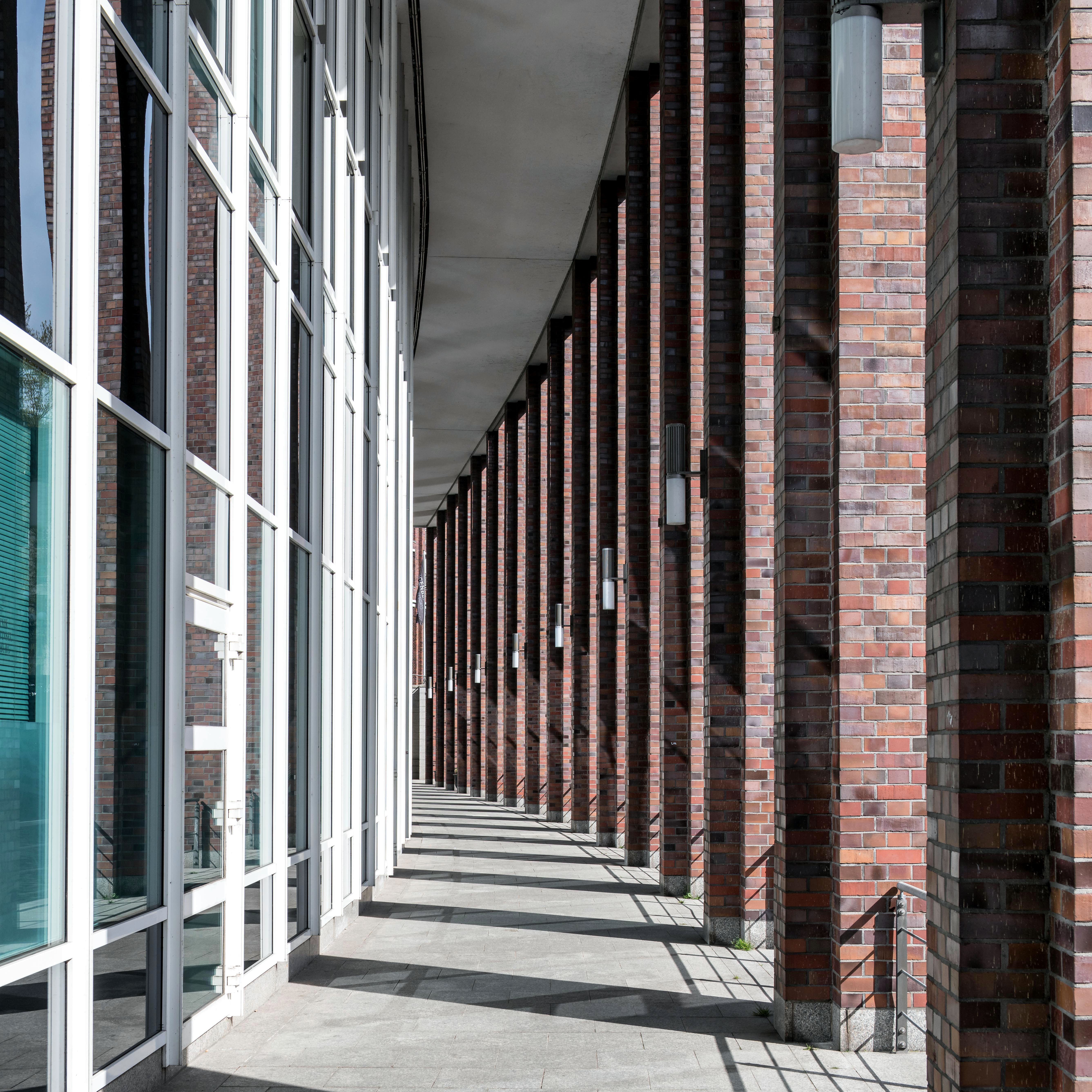 Columns by the Glass Building in Sunlight · Free Stock Photo