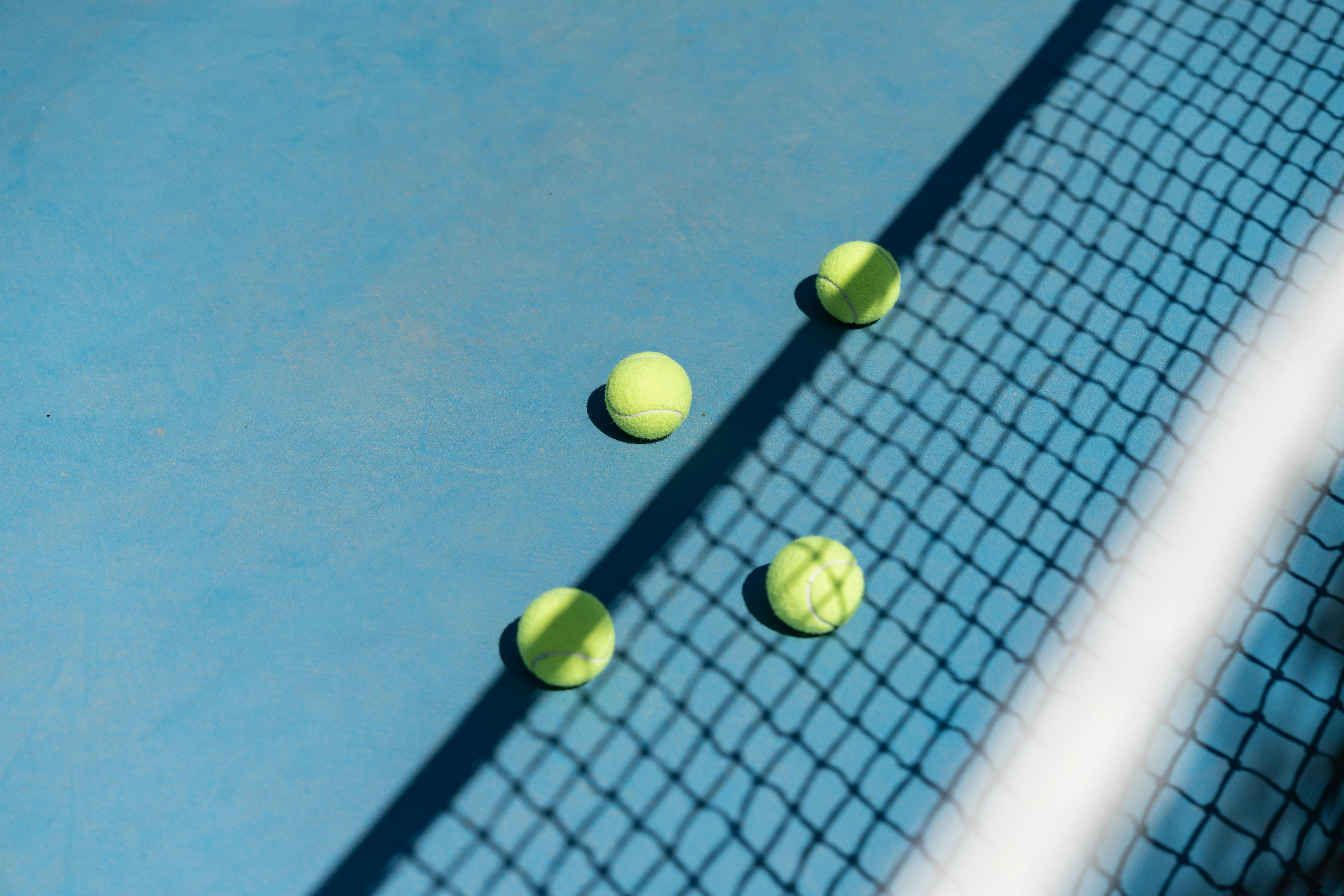 Tennis Balls behind Net · Free Stock Photo