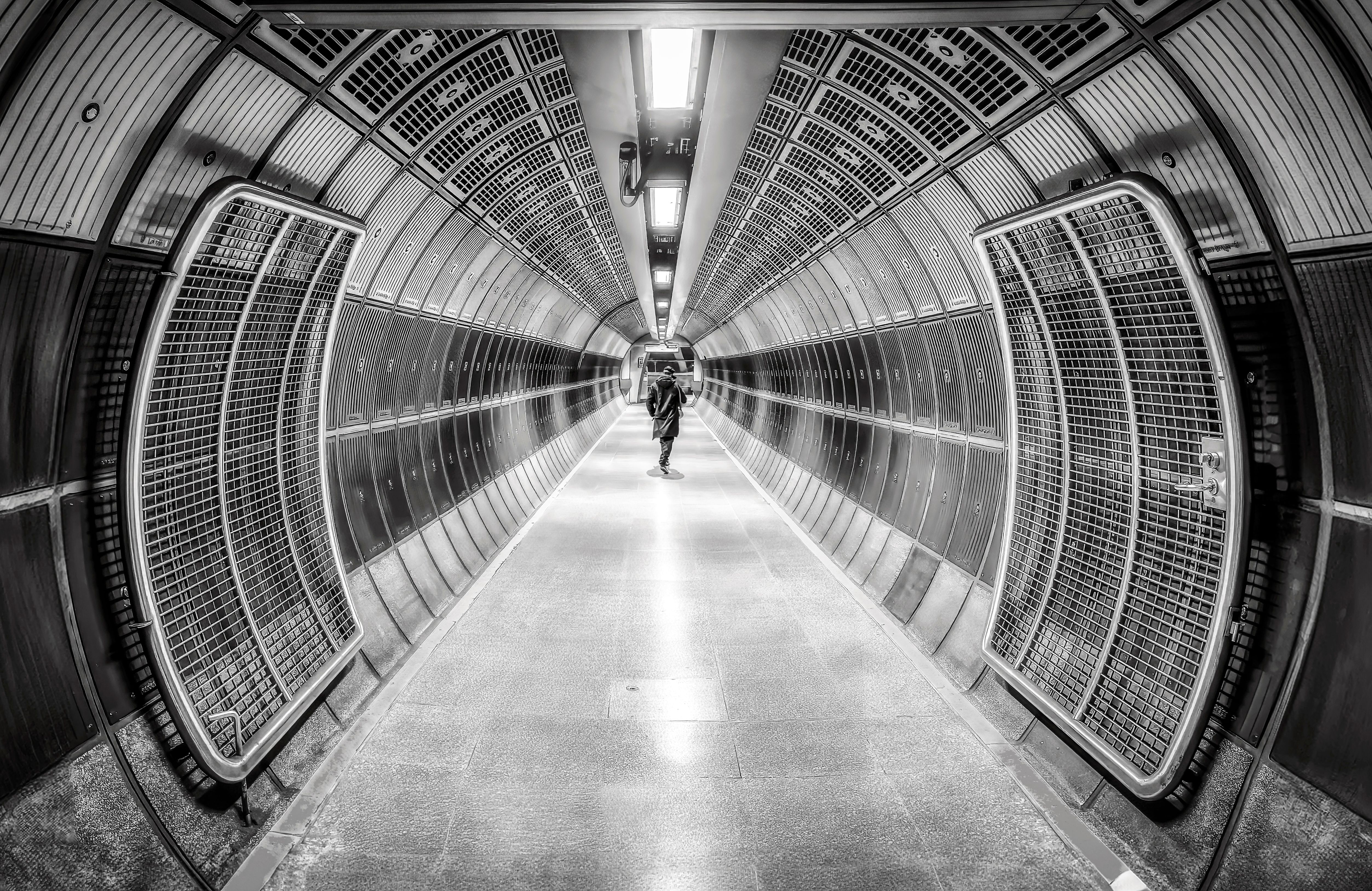 Back View of a Person Walking in a Tunnel · Free Stock Photo