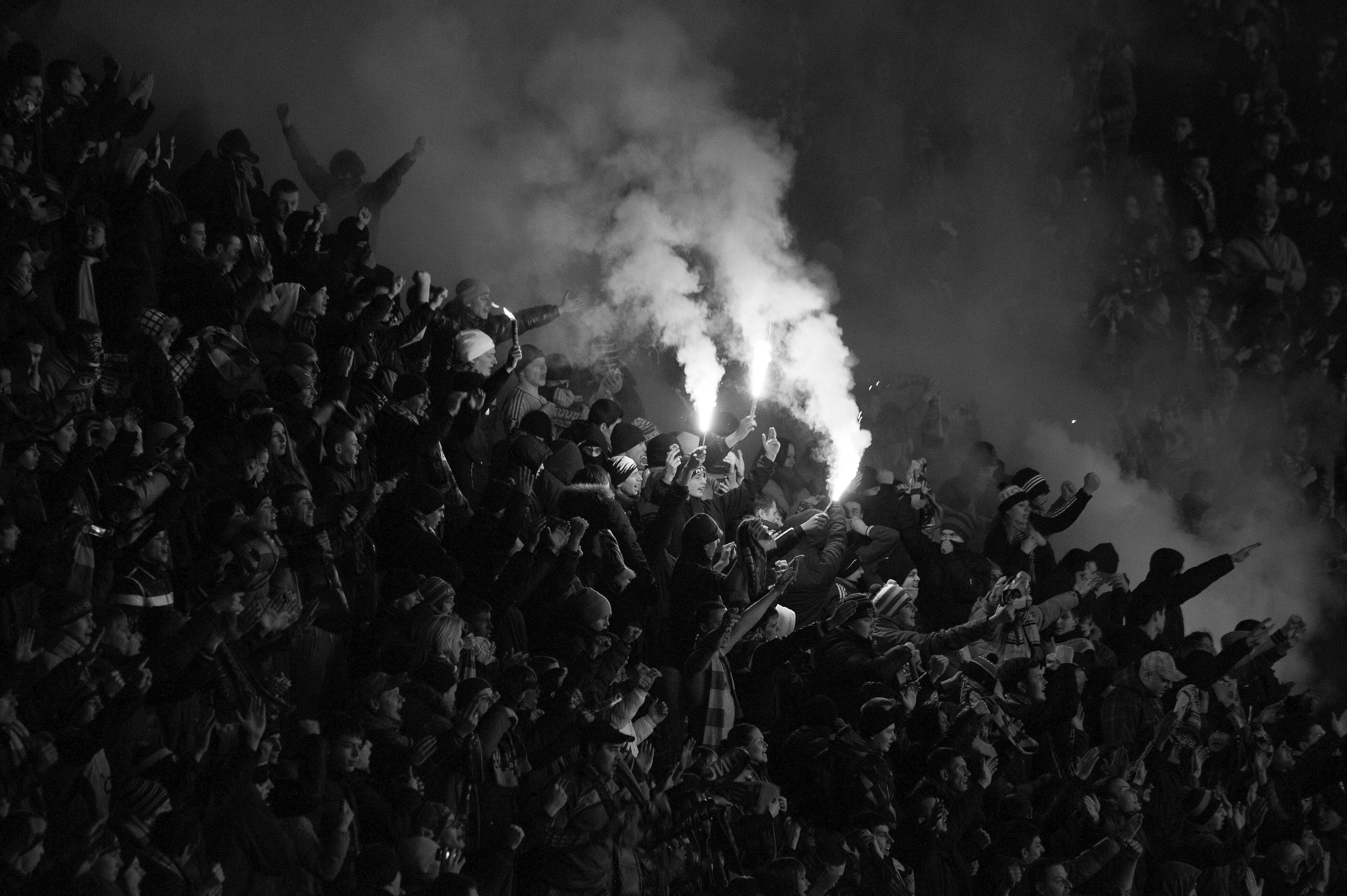 Smoking Flares in Hands of Fans in Stands · Free Stock Photo
