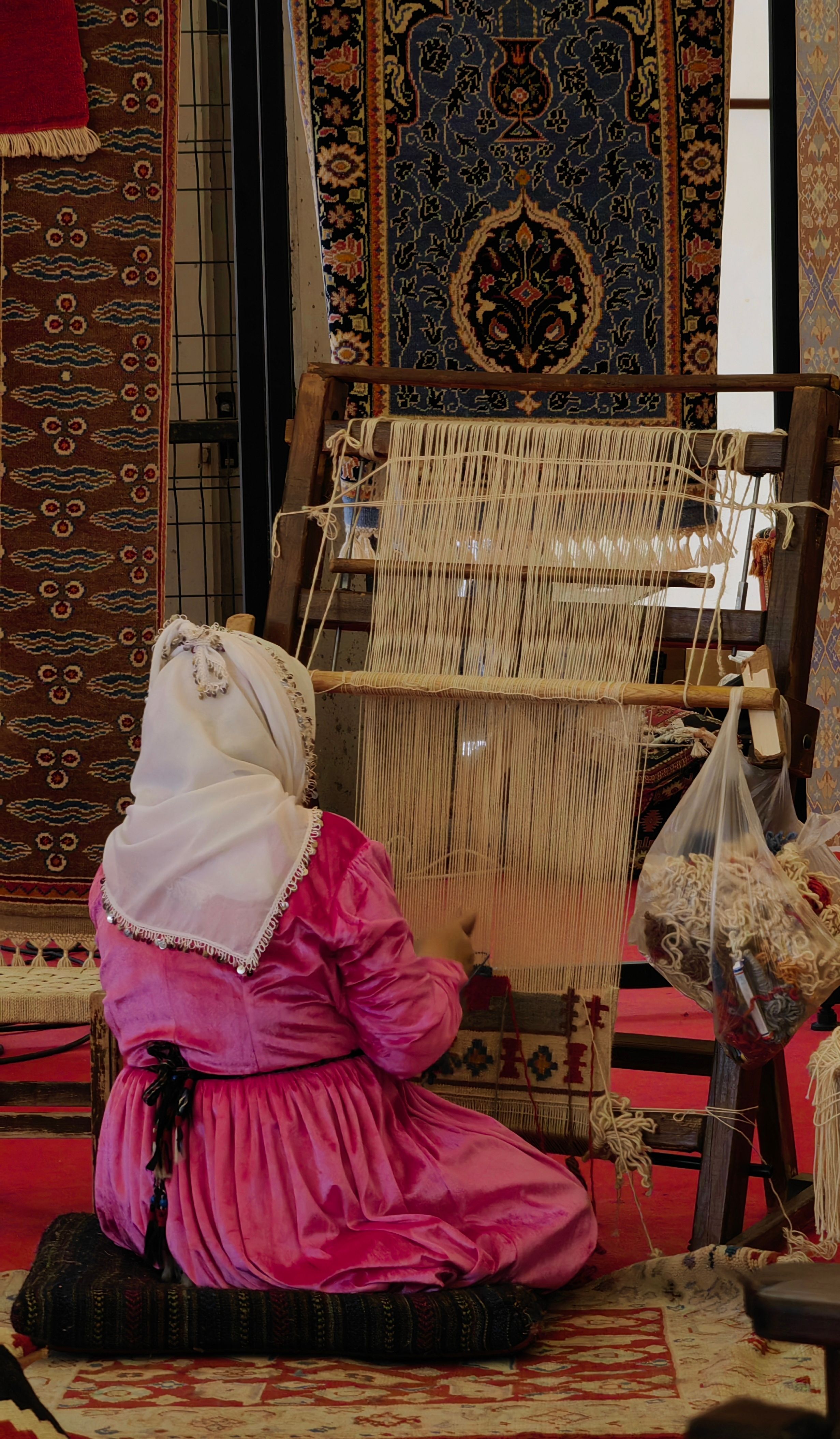 Woman Weaving Carpet in Workshop · Free Stock Photo