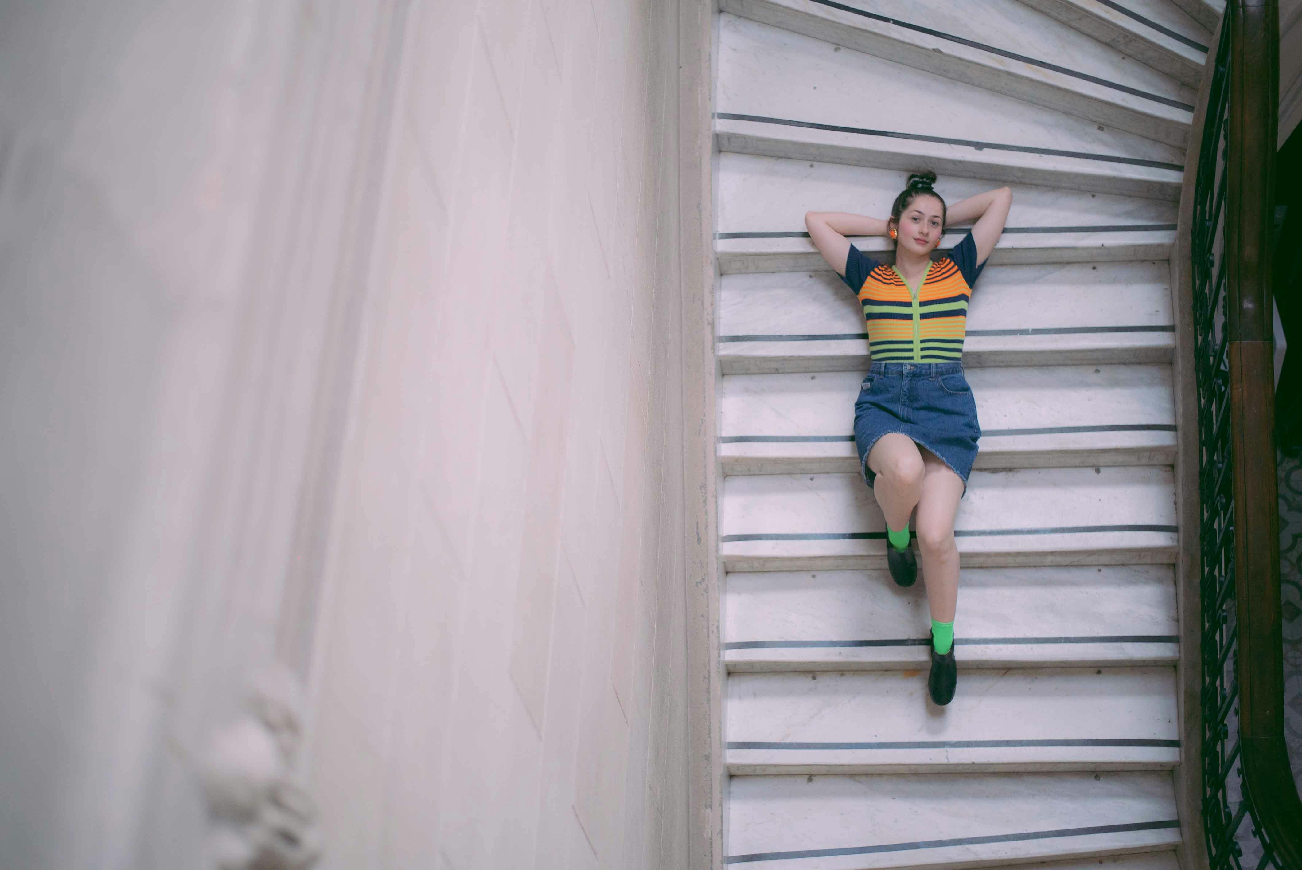 Model in Denim Skirt Posing on Steps · Free Stock Photo