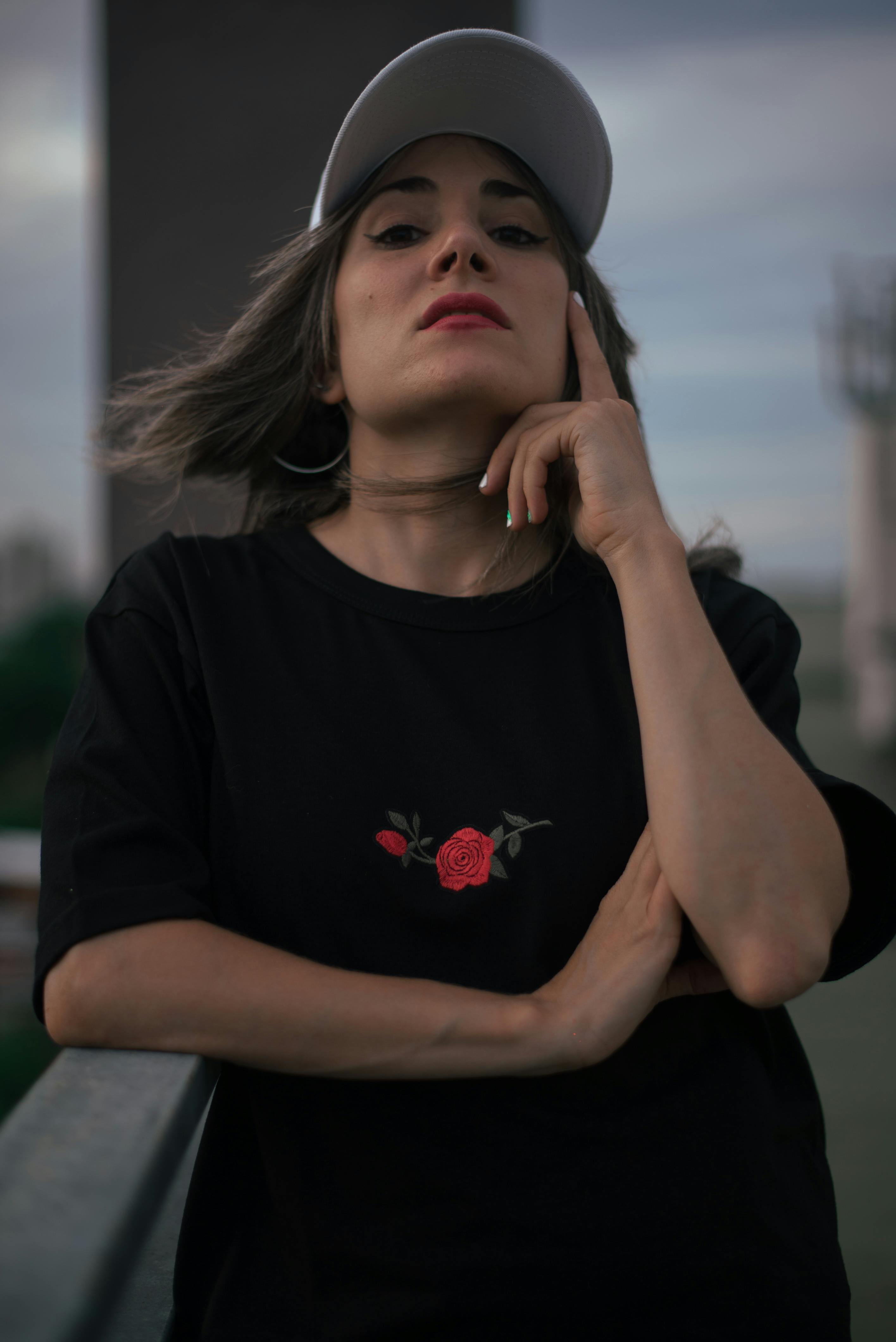 A woman wearing a black shirt with roses on it · Free Stock Photo
