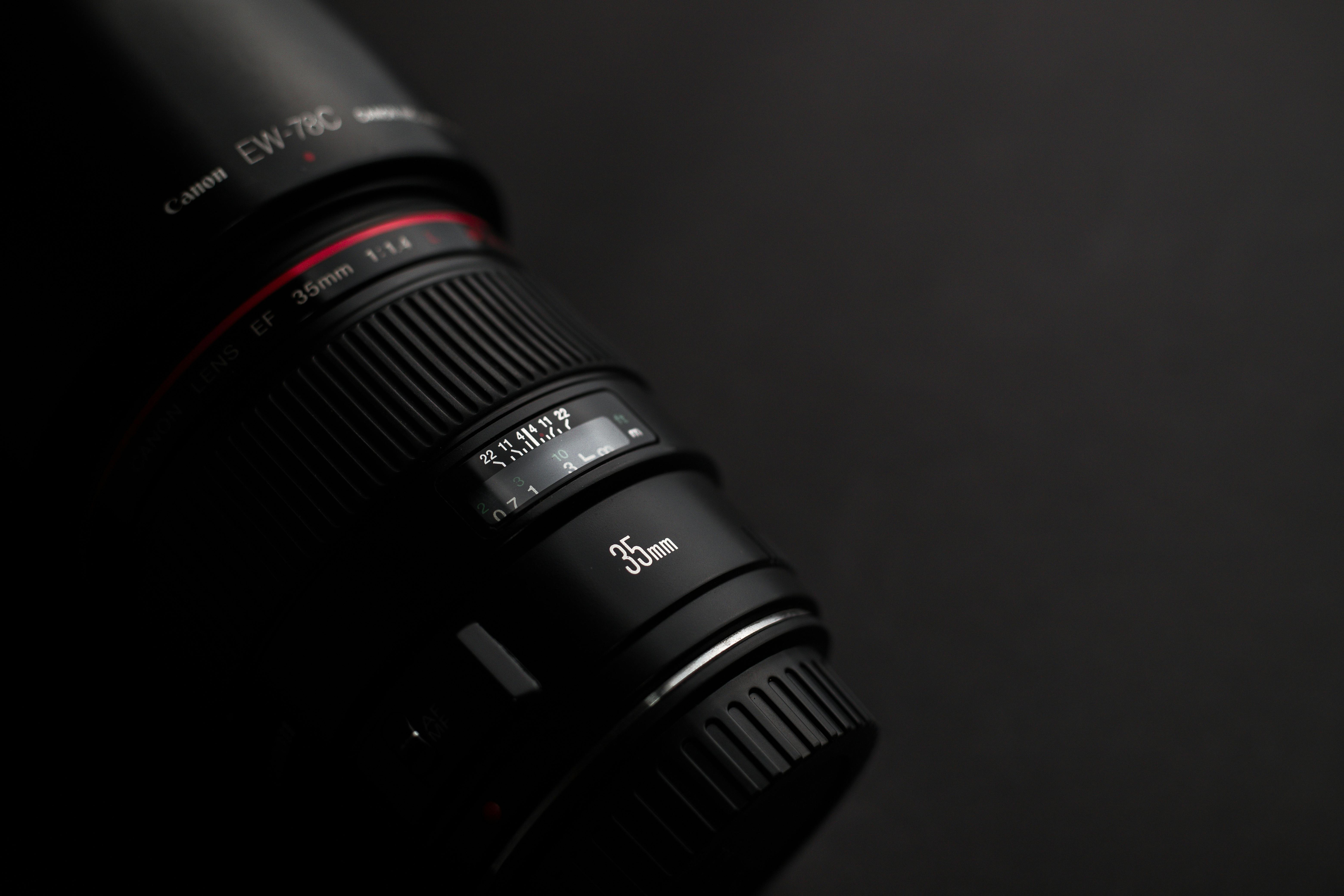 Black Dslr Camera Lens On Black Surface · Free Stock Photo