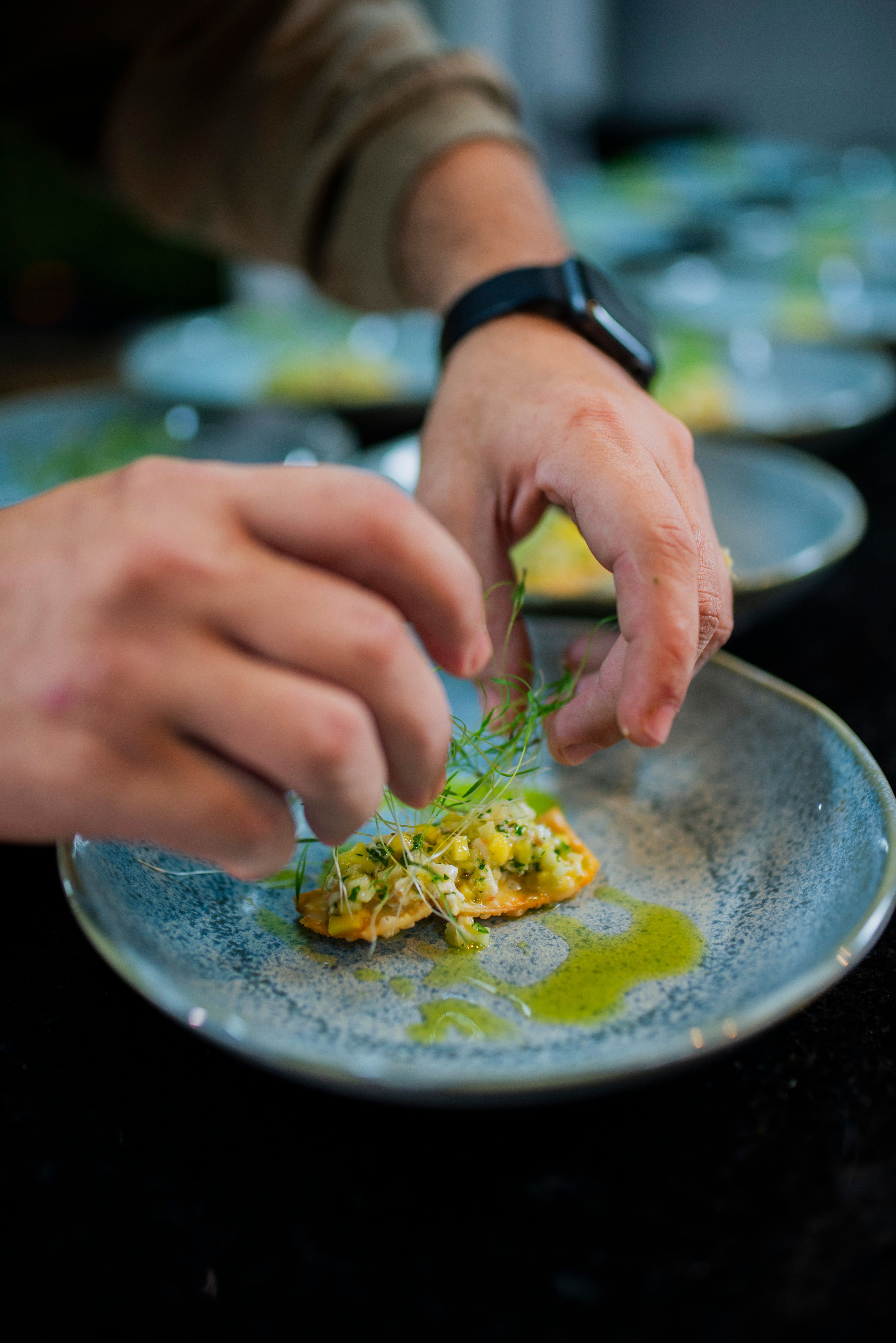 A person is preparing food on a plate · Free Stock Photo