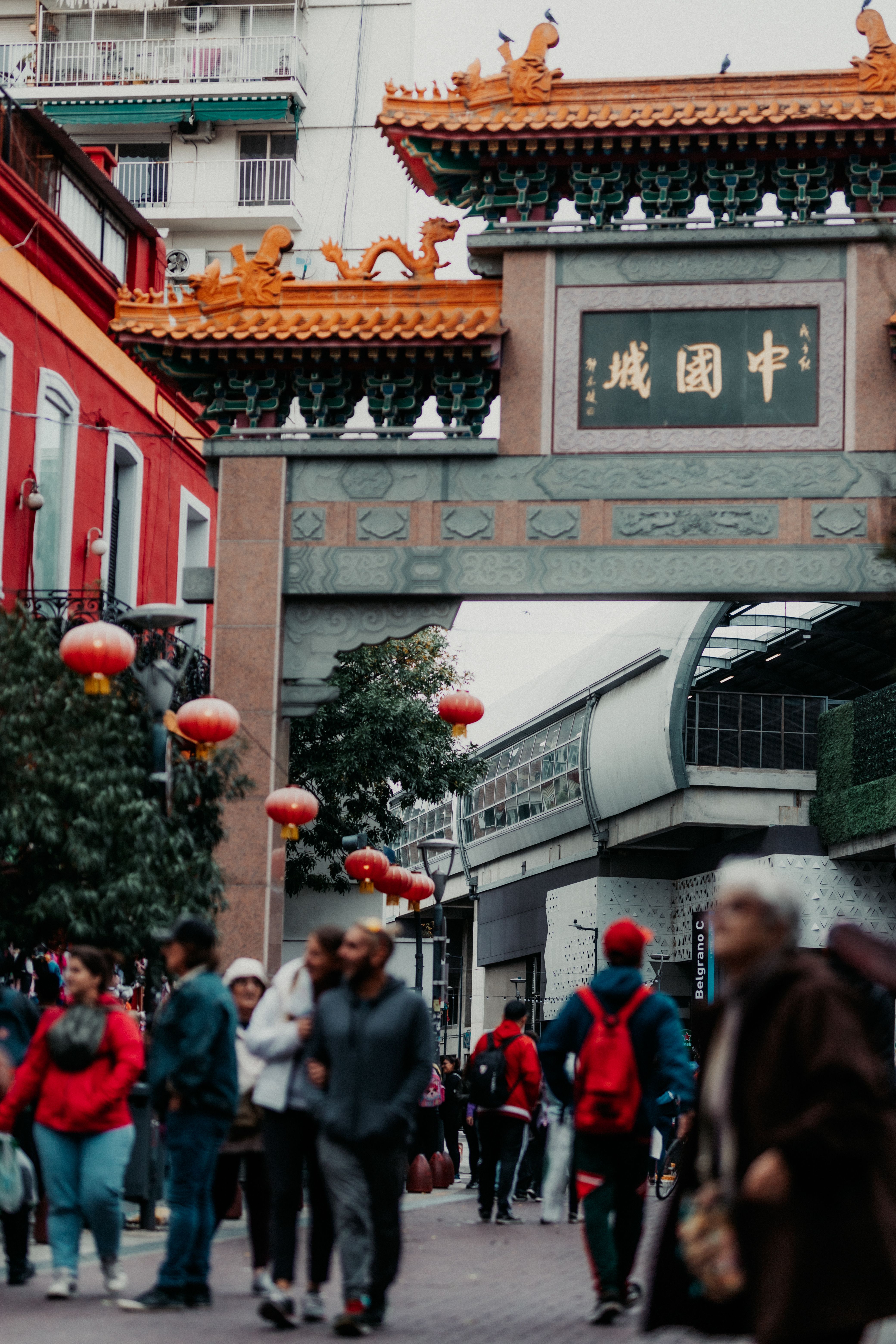 People Walking under Gate in Alley · Free Stock Photo