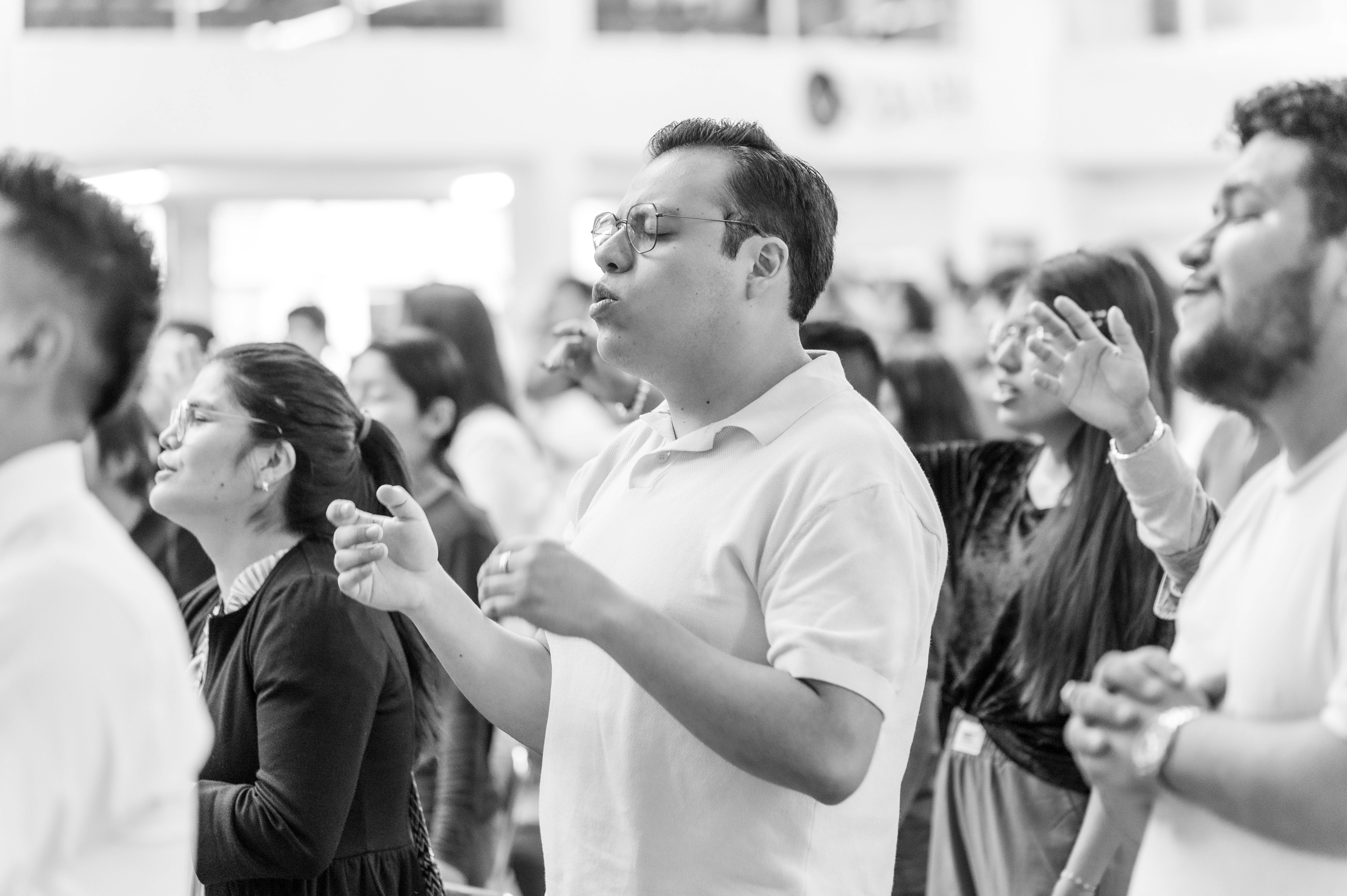 A group of people are singing and praying · Free Stock Photo