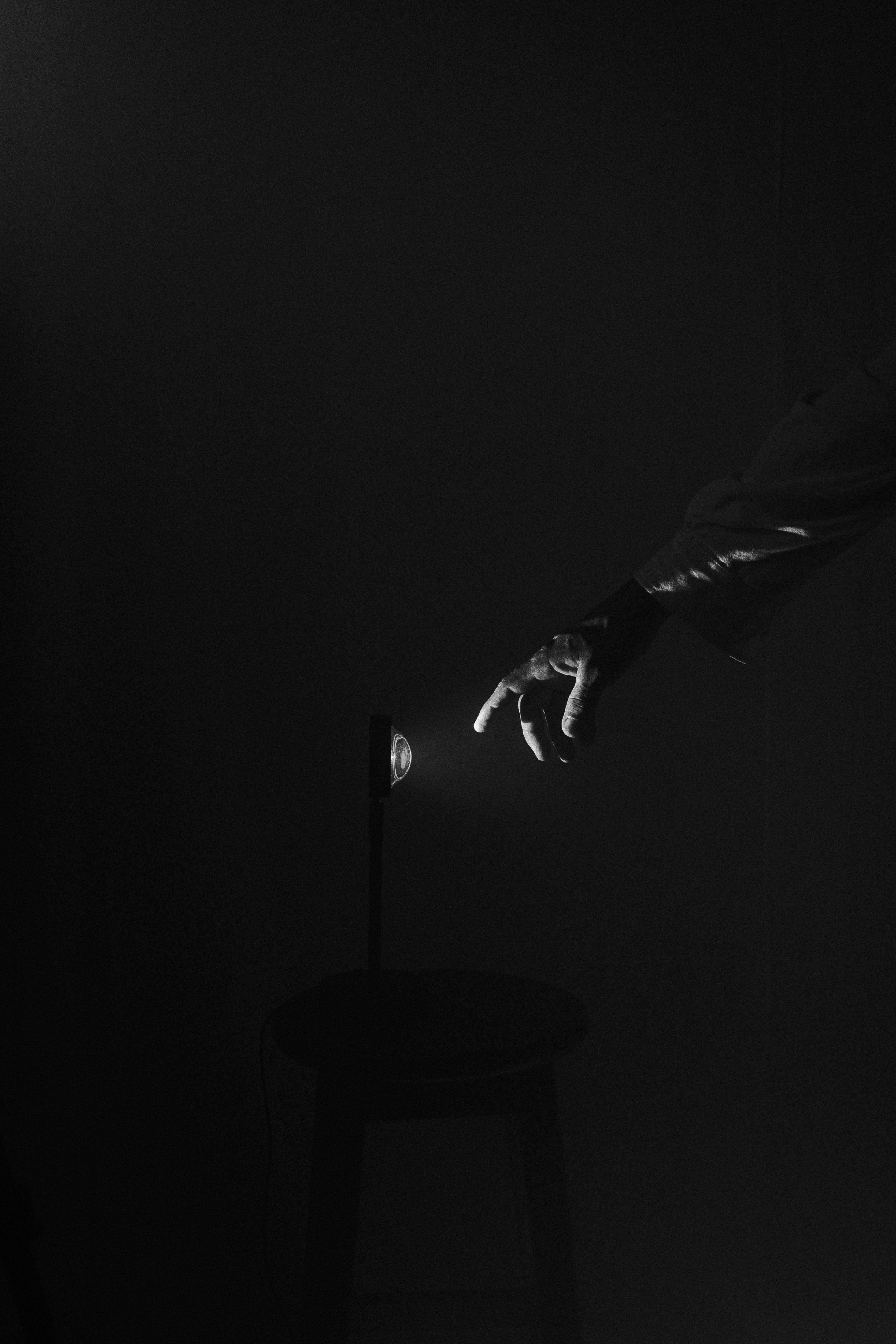 Person Hand over Light in Darkness · Free Stock Photo