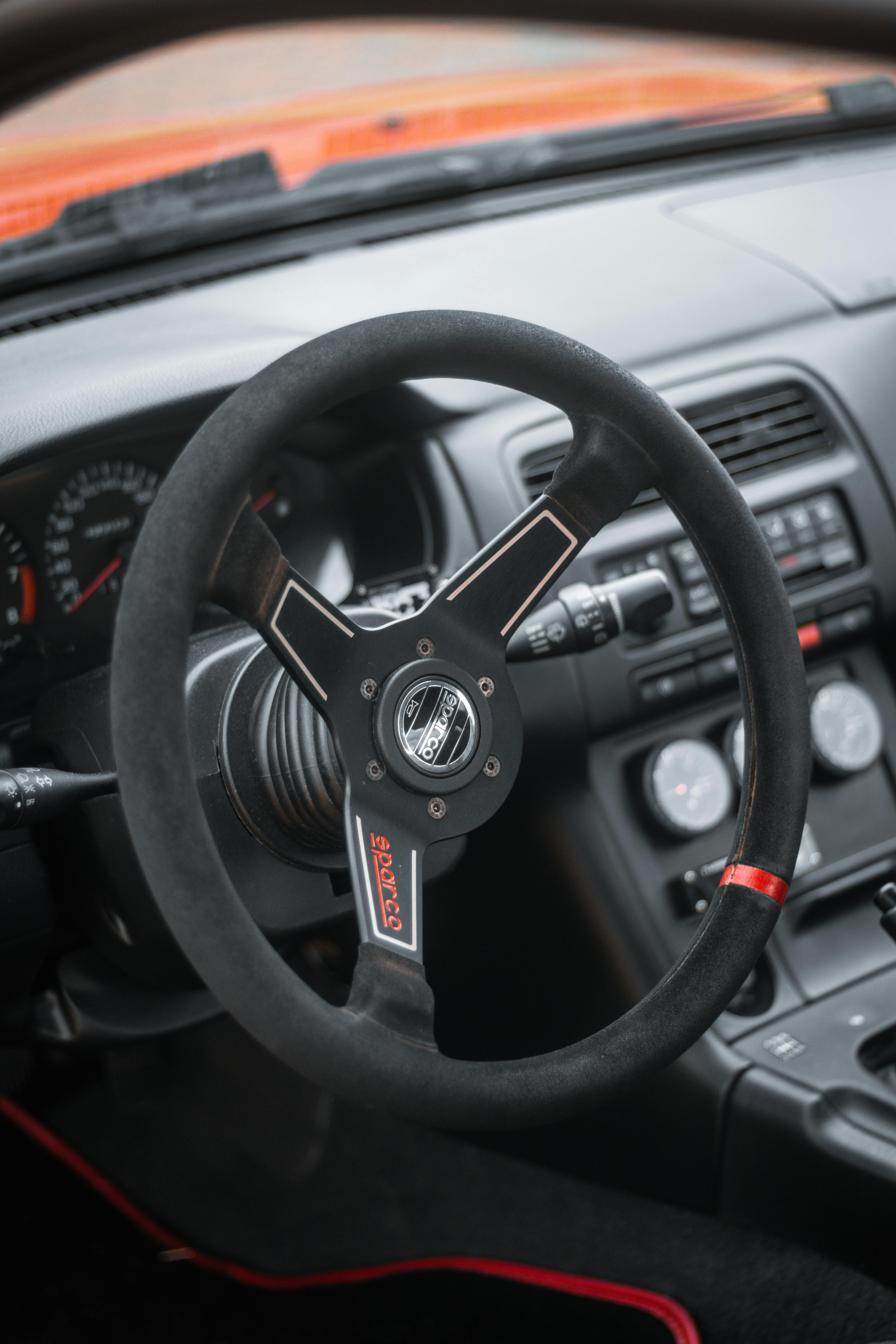 A steering wheel in a car with a black and red steering wheel · Free ...