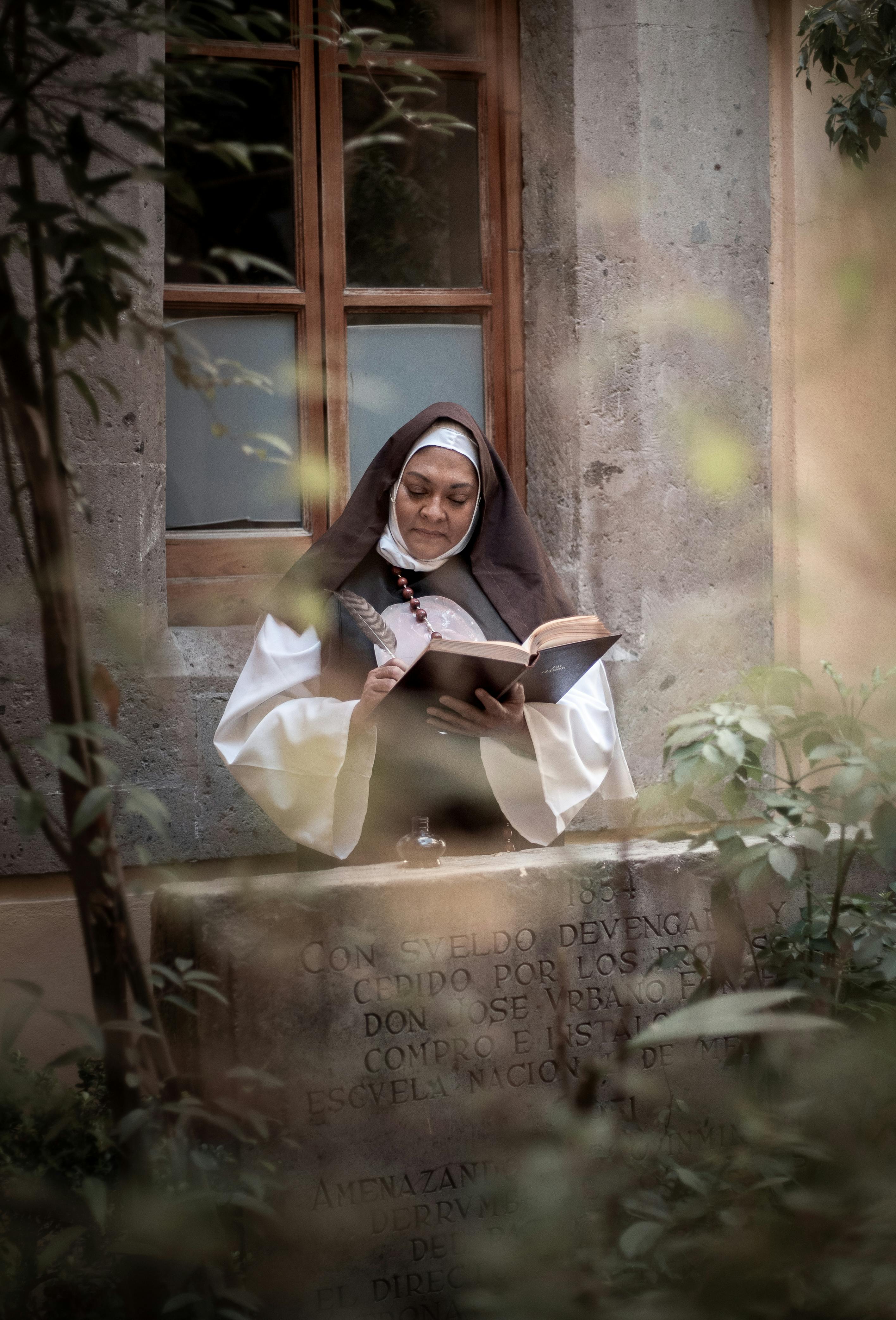 Nun Writing on Page of Book · Free Stock Photo
