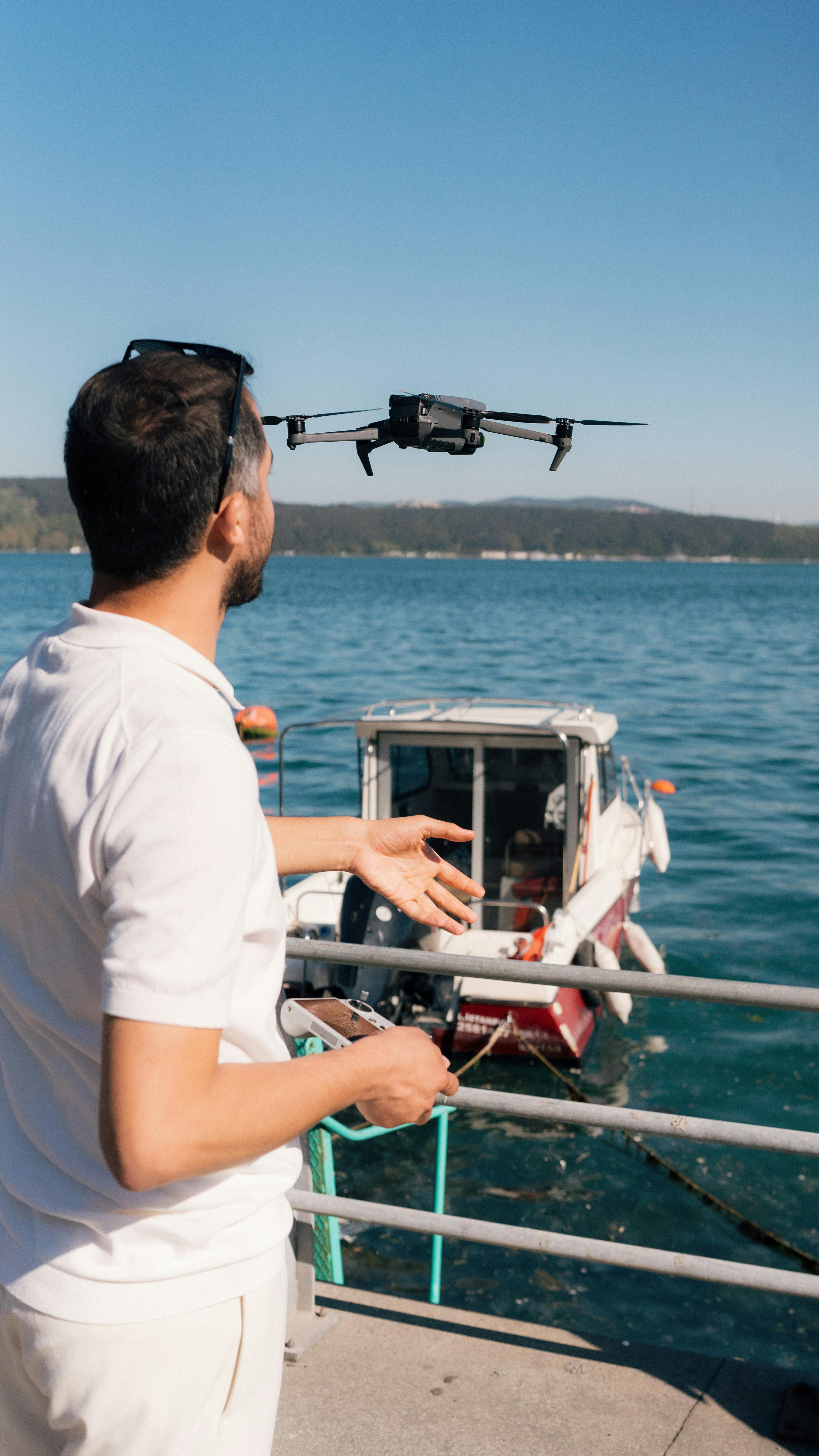Man Steering Drone by Sea · Free Stock Photo