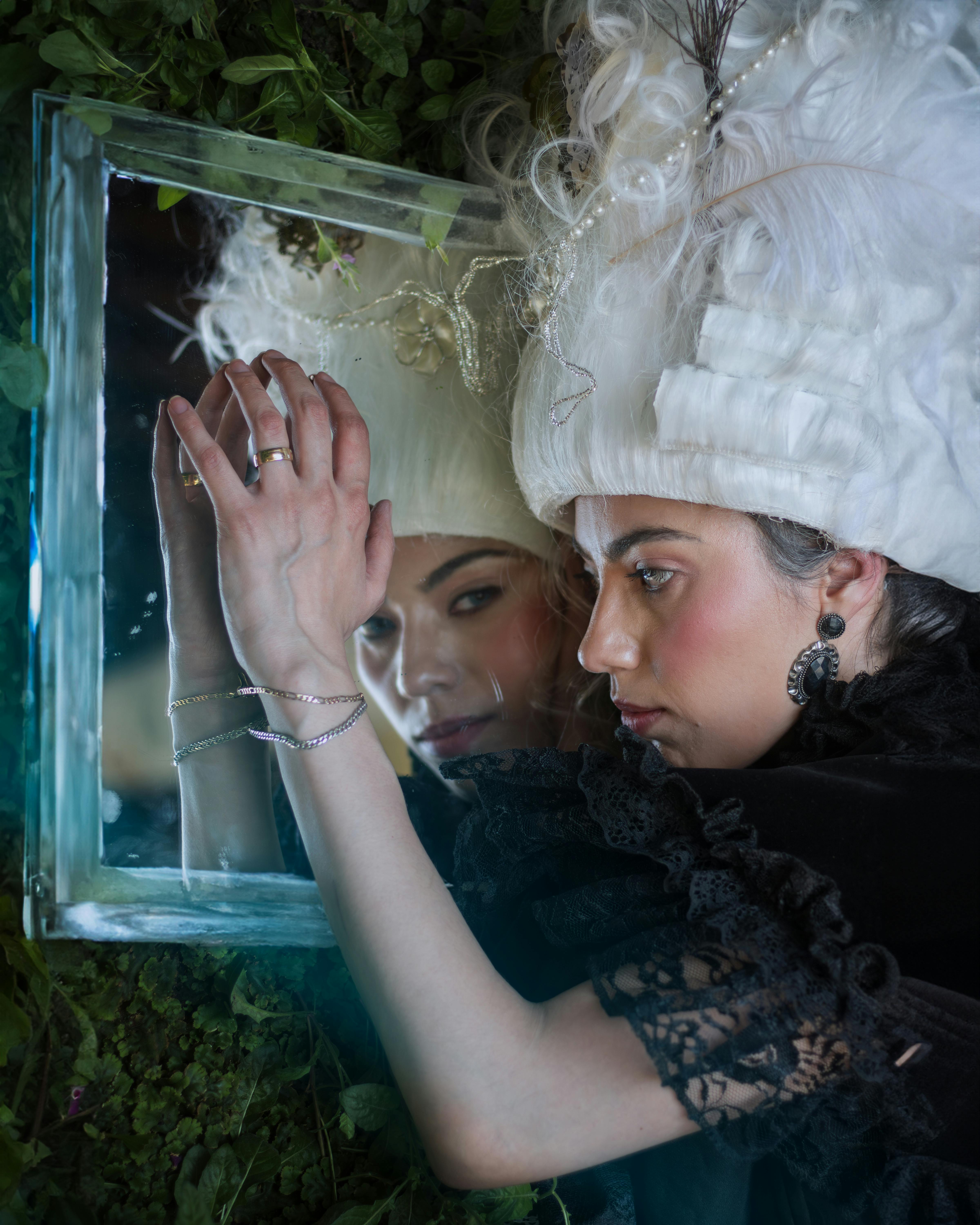 Woman in Wig Leaning on Mirror · Free Stock Photo