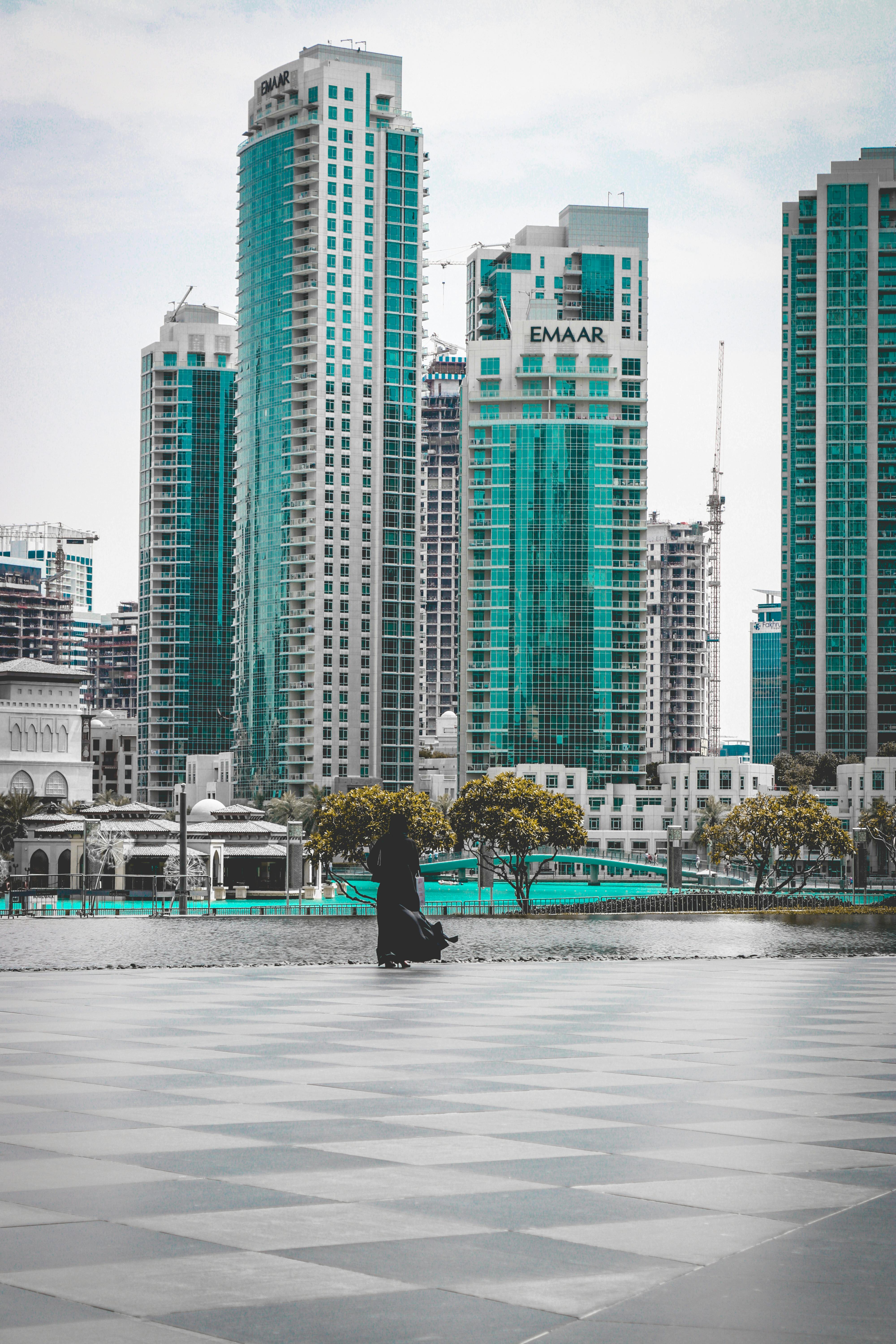 Woman Standing Facing High Rise Buildings · Free Stock Photo