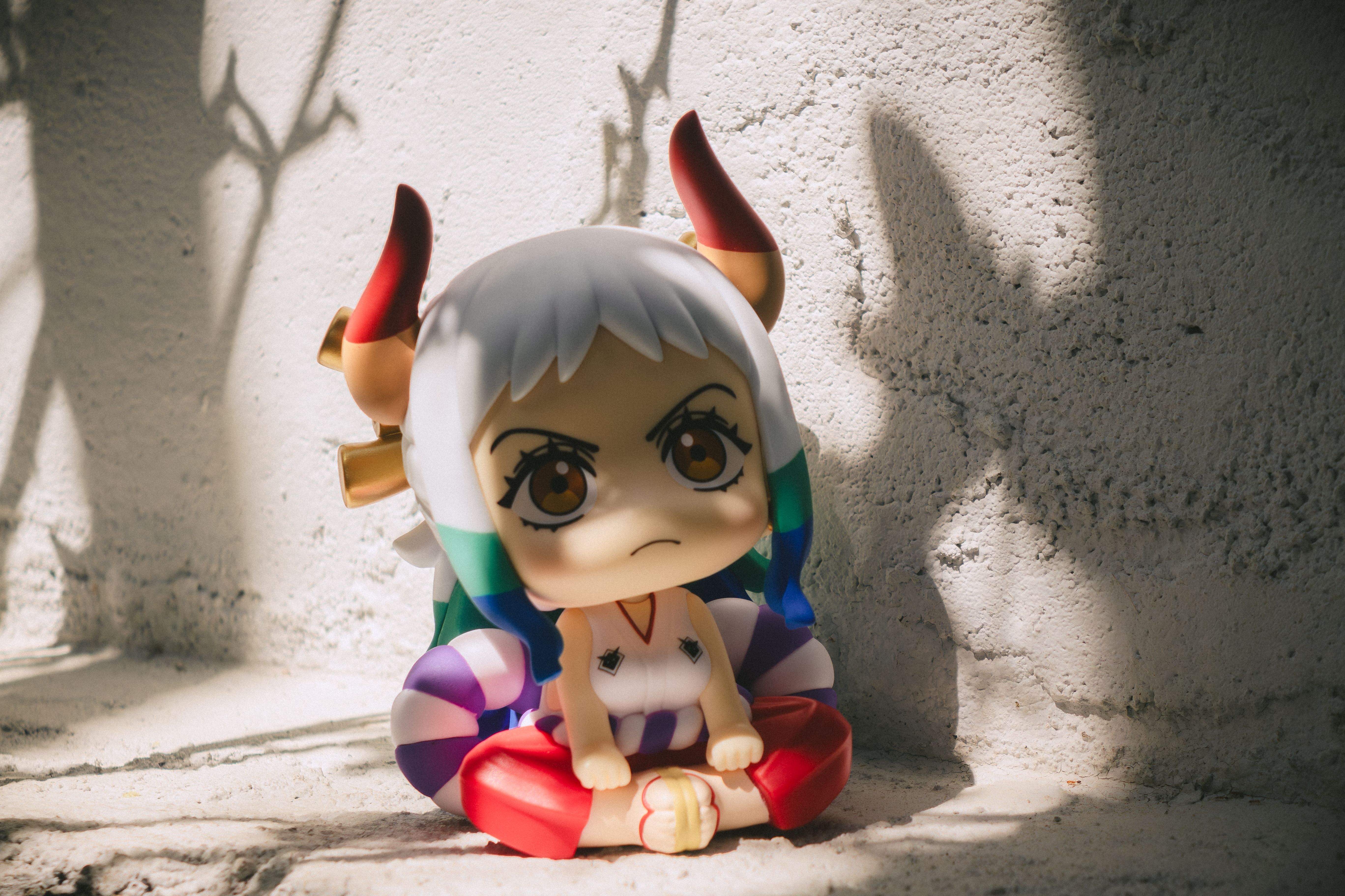 A toy with horns and horns sitting on the ground · Free Stock Photo