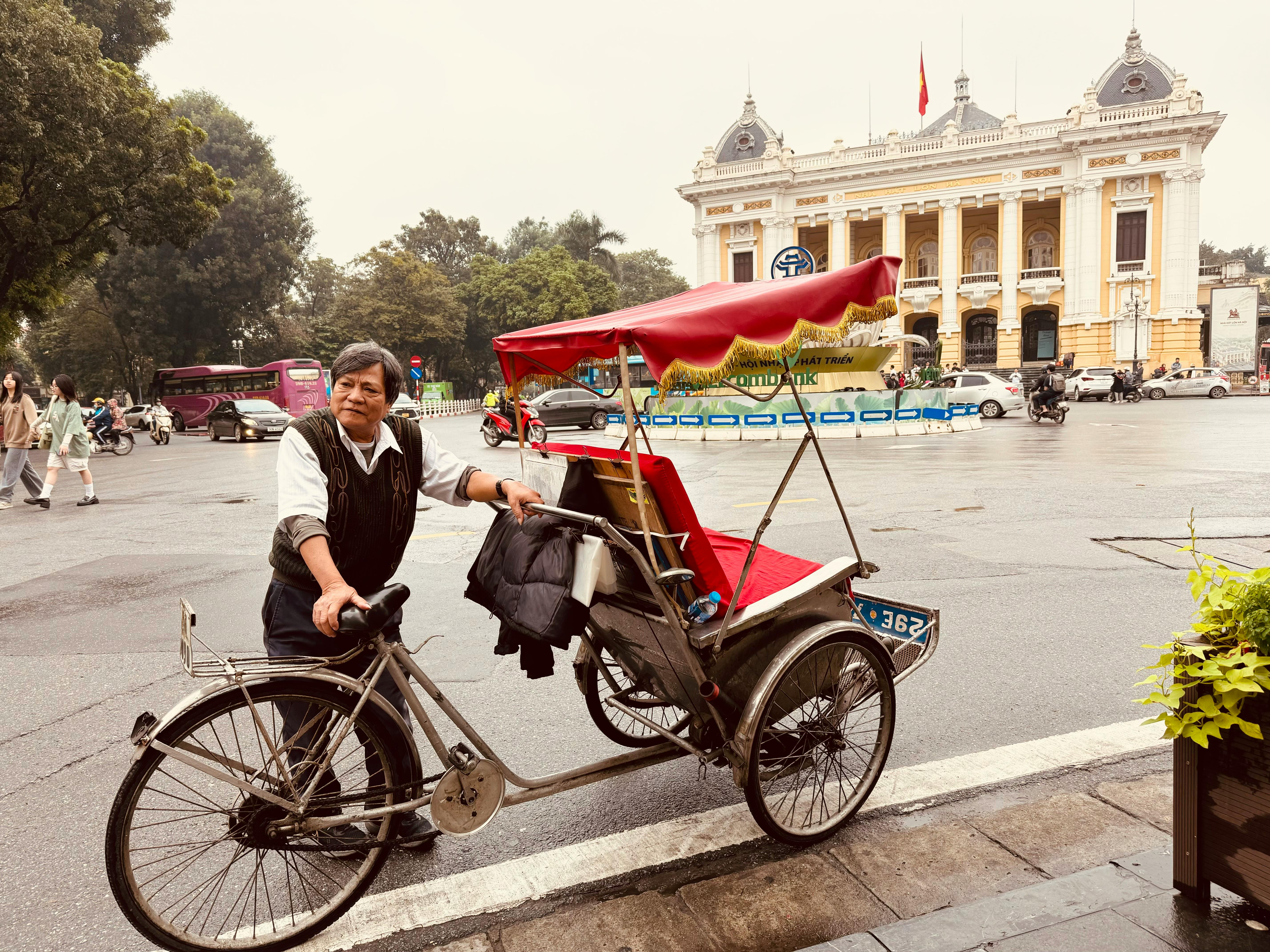 Man with Rickshaw on Street near Hanoi Opera House · Free Stock Photo
