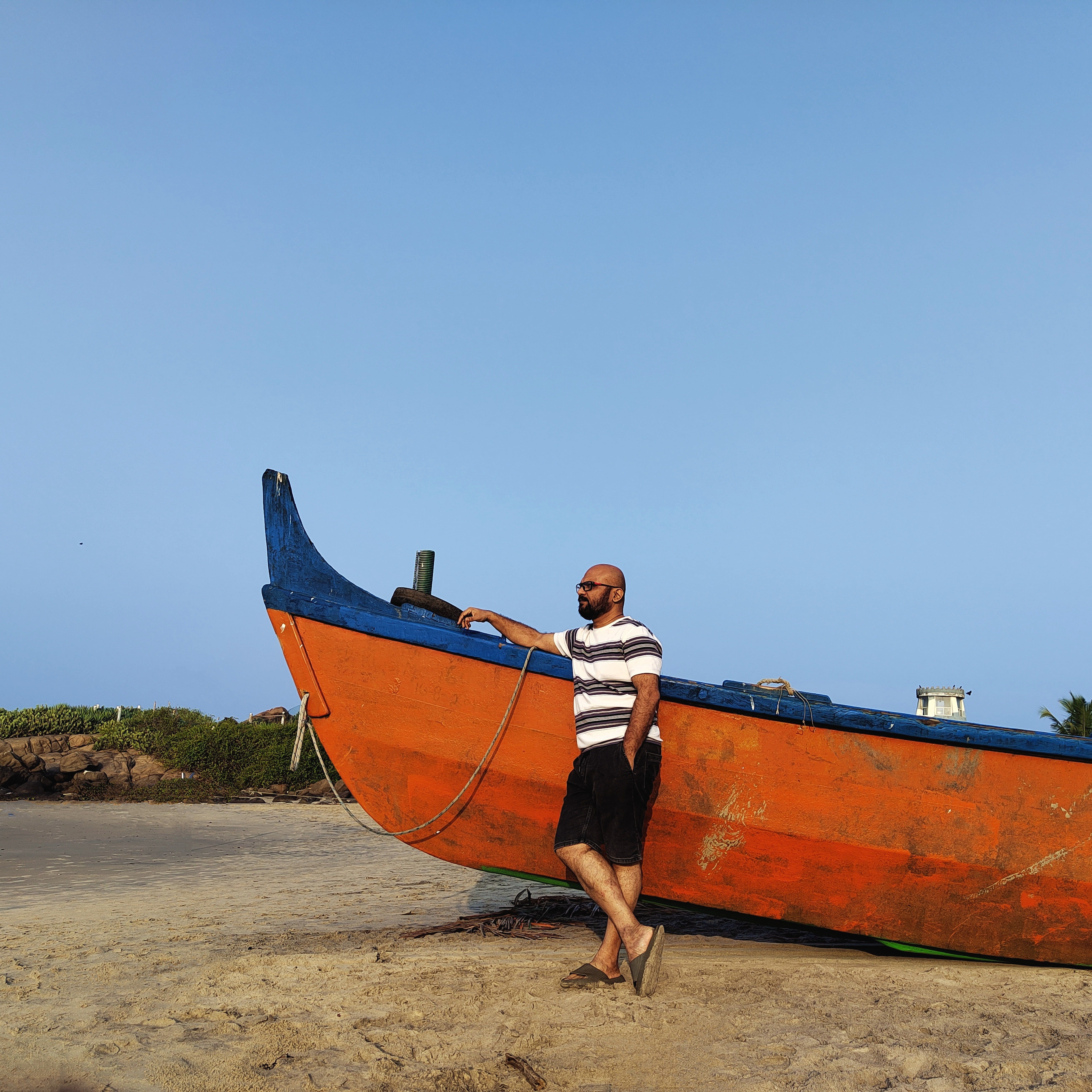 Man Standing with Boat on Beach · Free Stock Photo