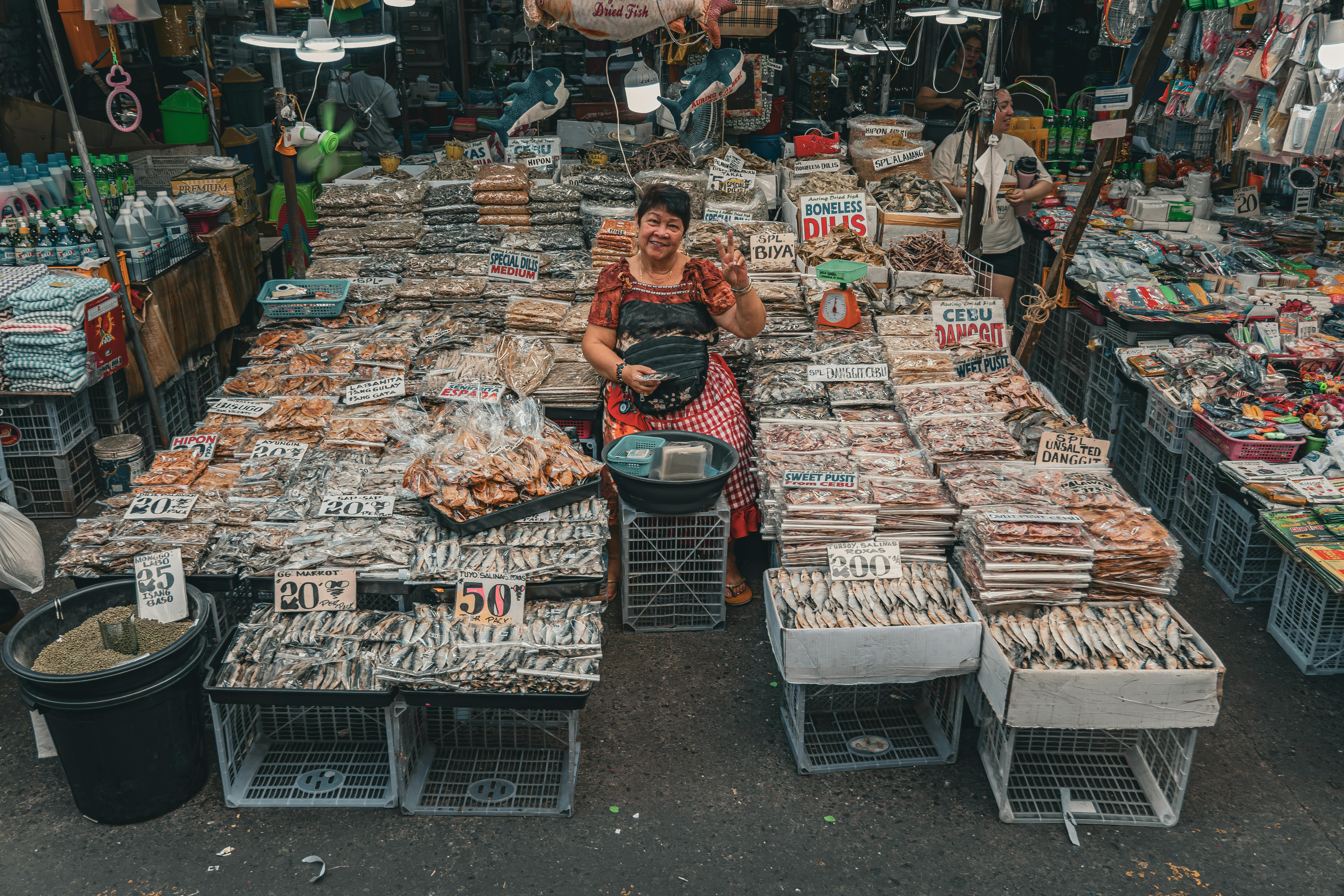 A Happy Woman Selling Fish at a Fish Market · Free Stock Photo
