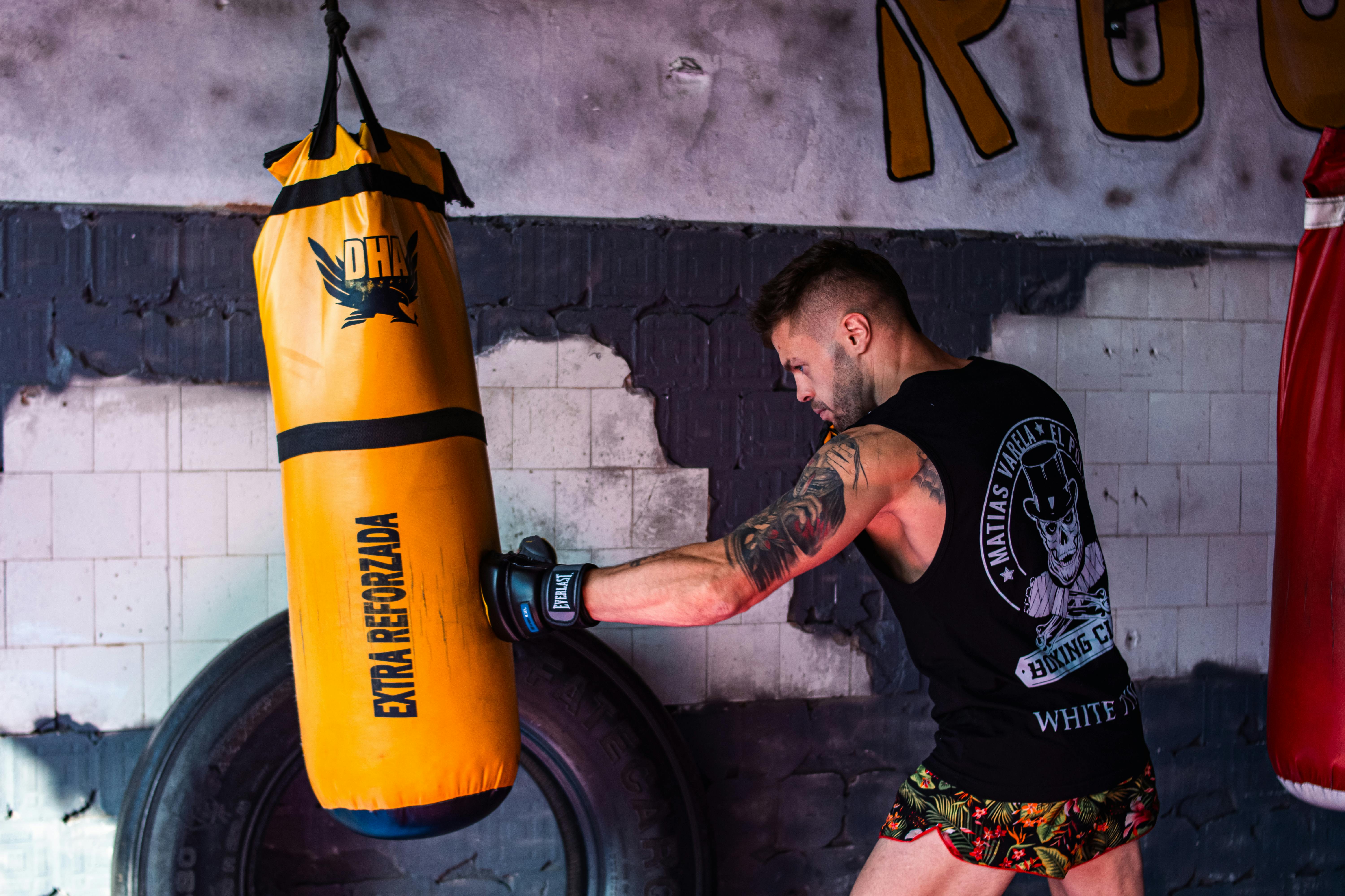 Man Fighting with Punching Bag · Free Stock Photo