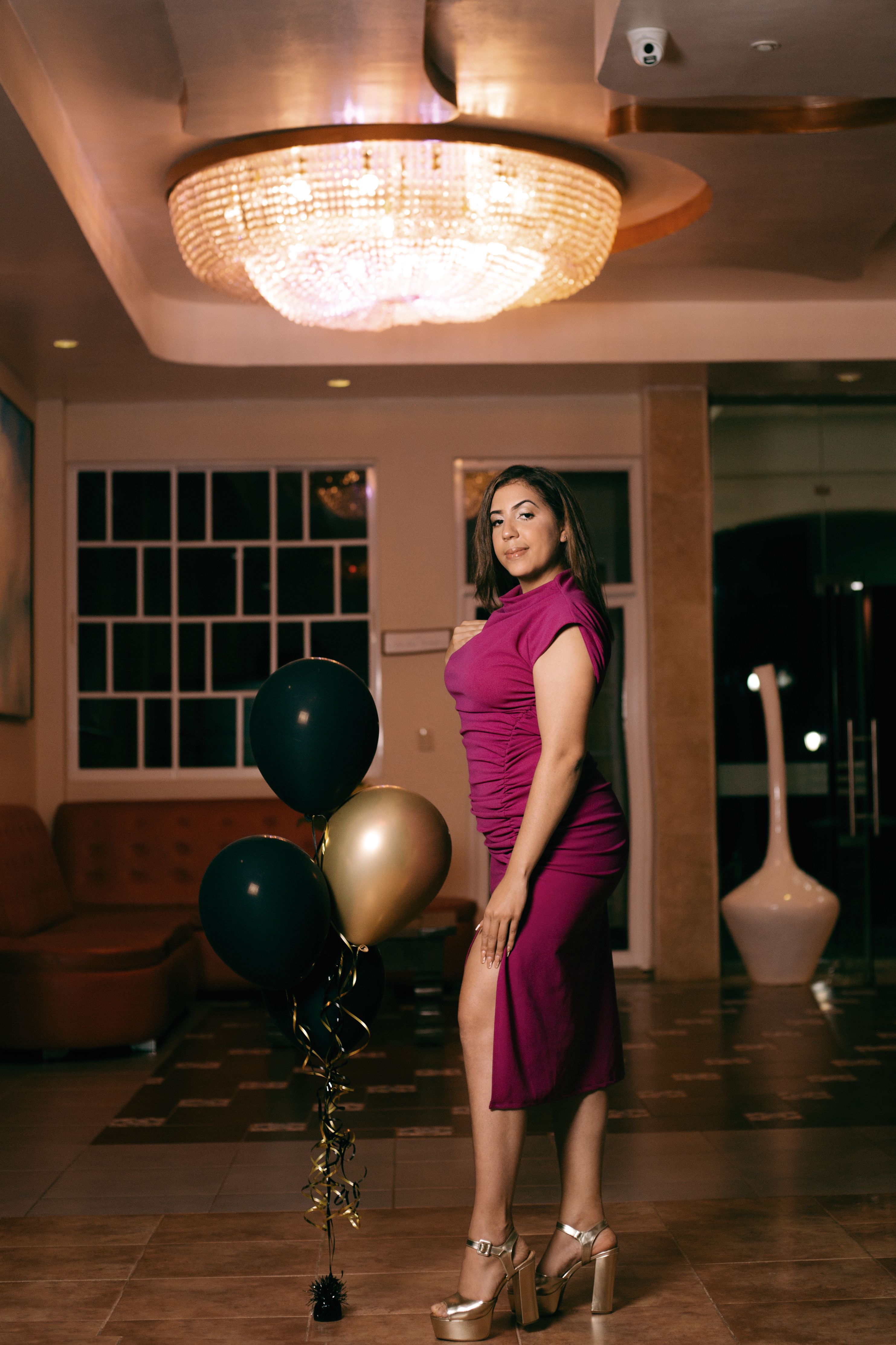Elegant Woman in Purple Dress Posing by Balloons on Floor · Free Stock ...