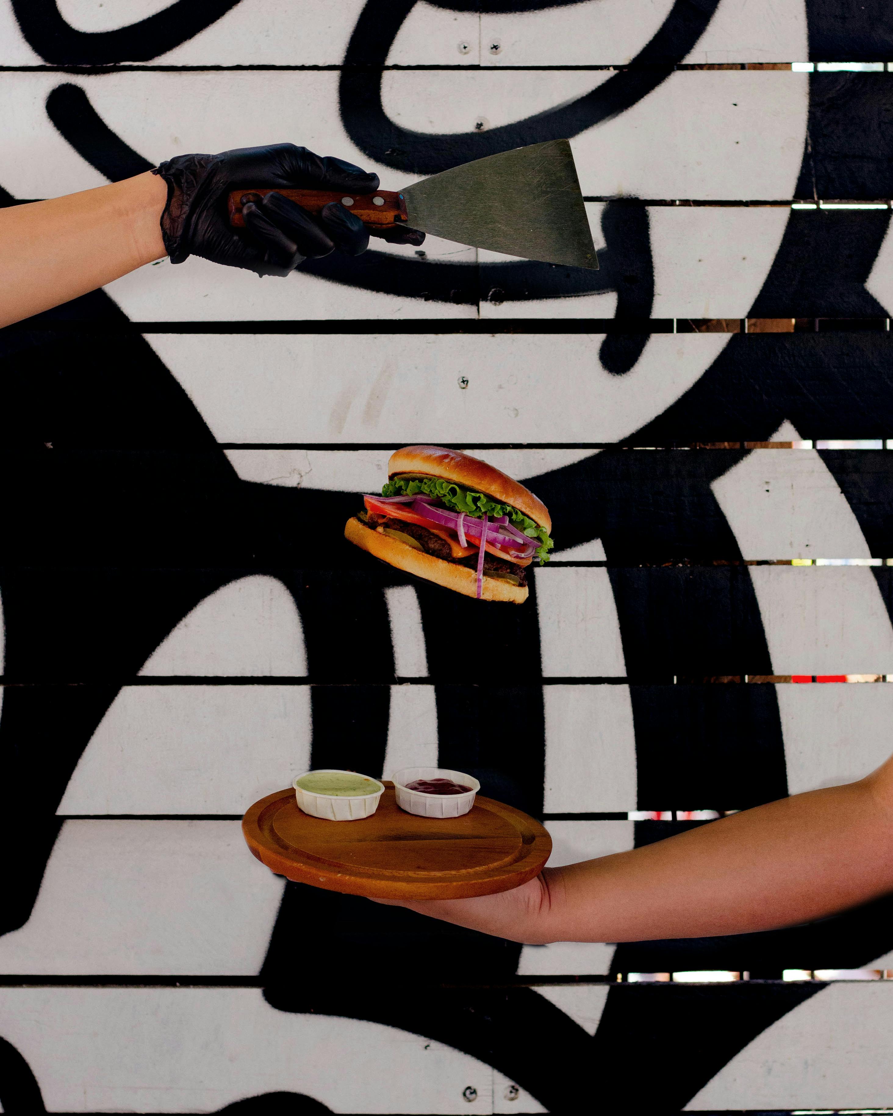 A Burger Falling Onto a Tray · Free Stock Photo