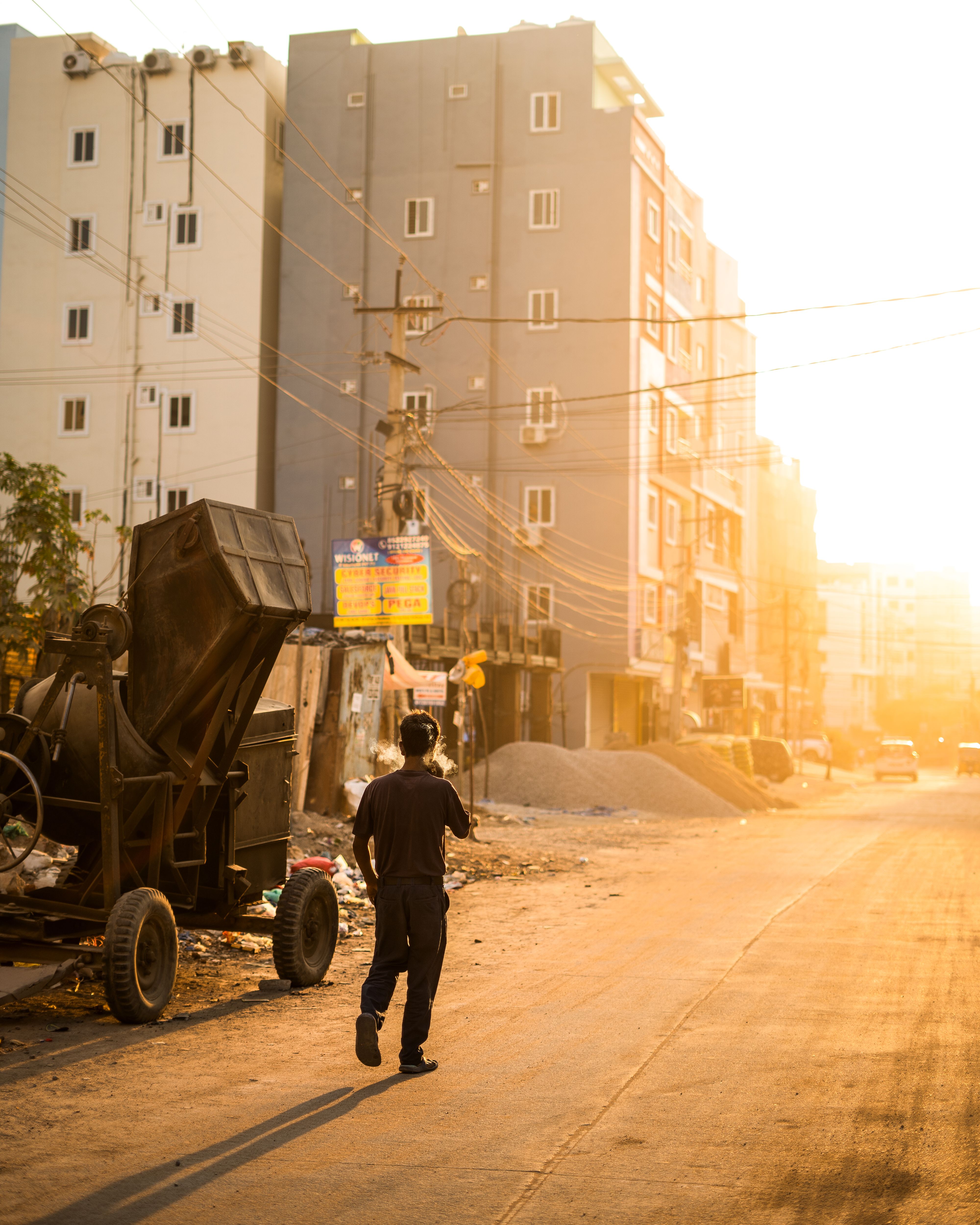 Man Walking on Street in Town at Sunset · Free Stock Photo