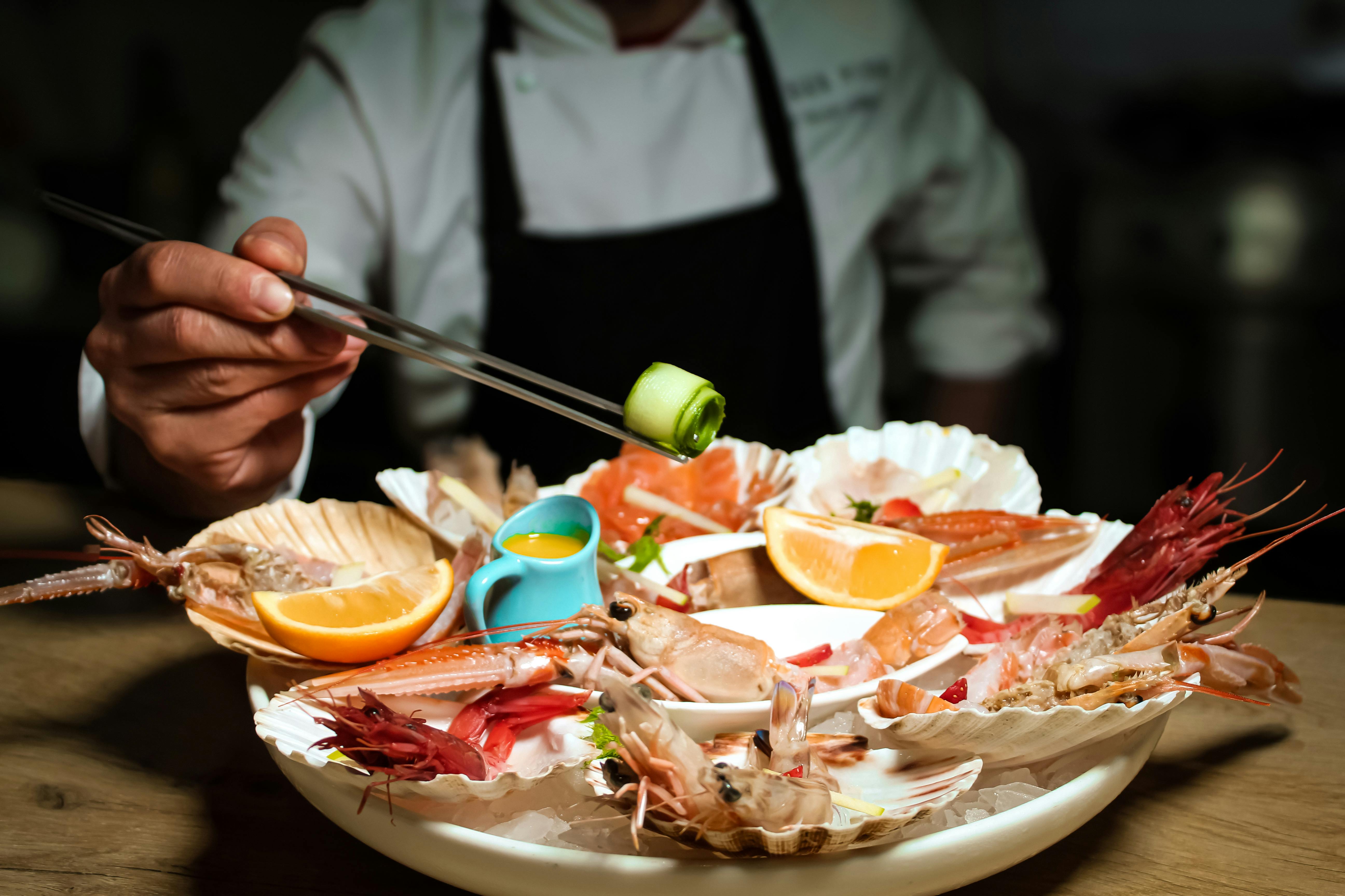 Hand of Man Eating Seafood with Chopsticks · Free Stock Photo