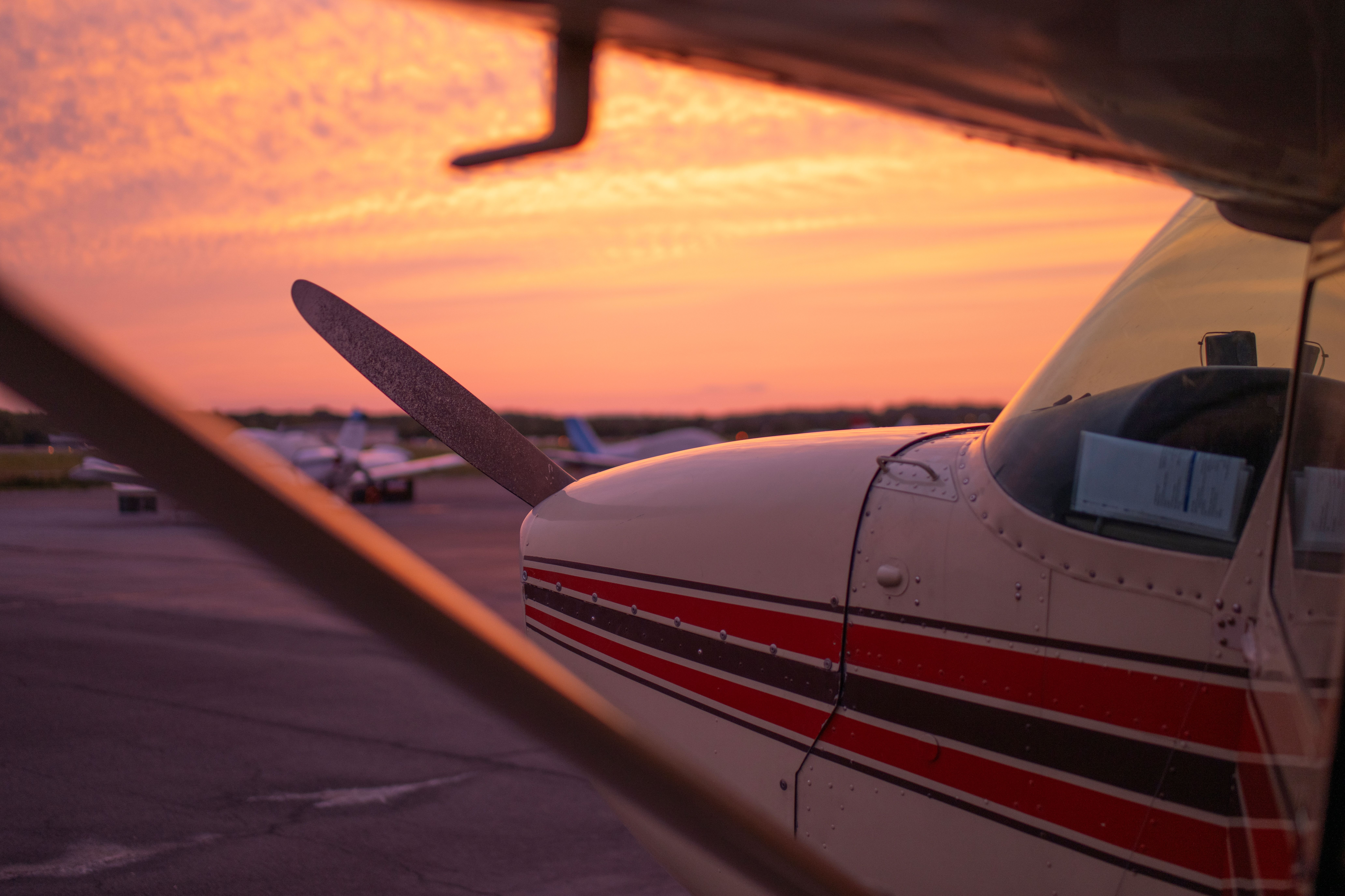Close-up od a Propeller Airplane on the Tarmac at Sunset · Free Stock Photo